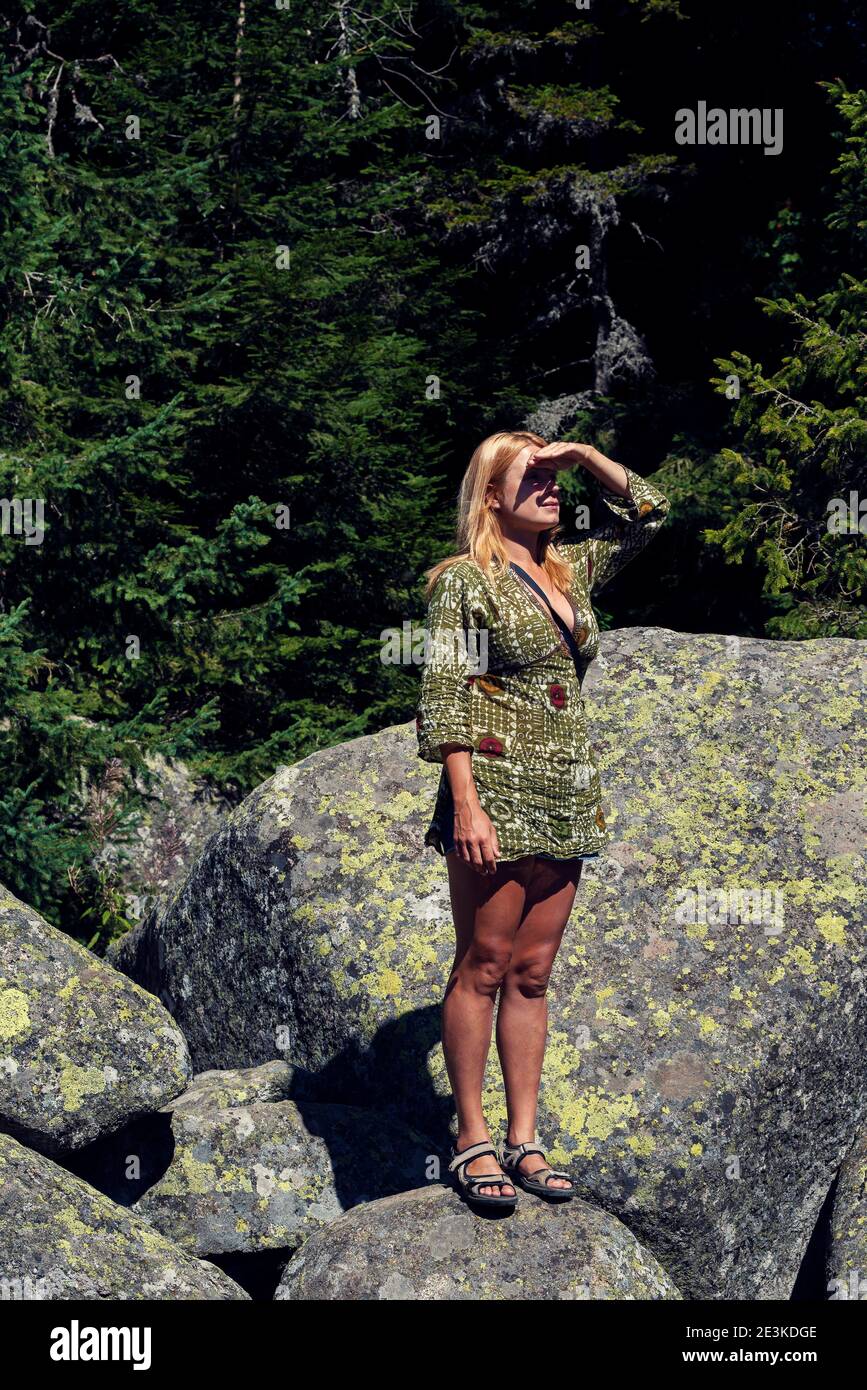 Beautiful Polish woman standing on stone in a stone river in Vitosha ...