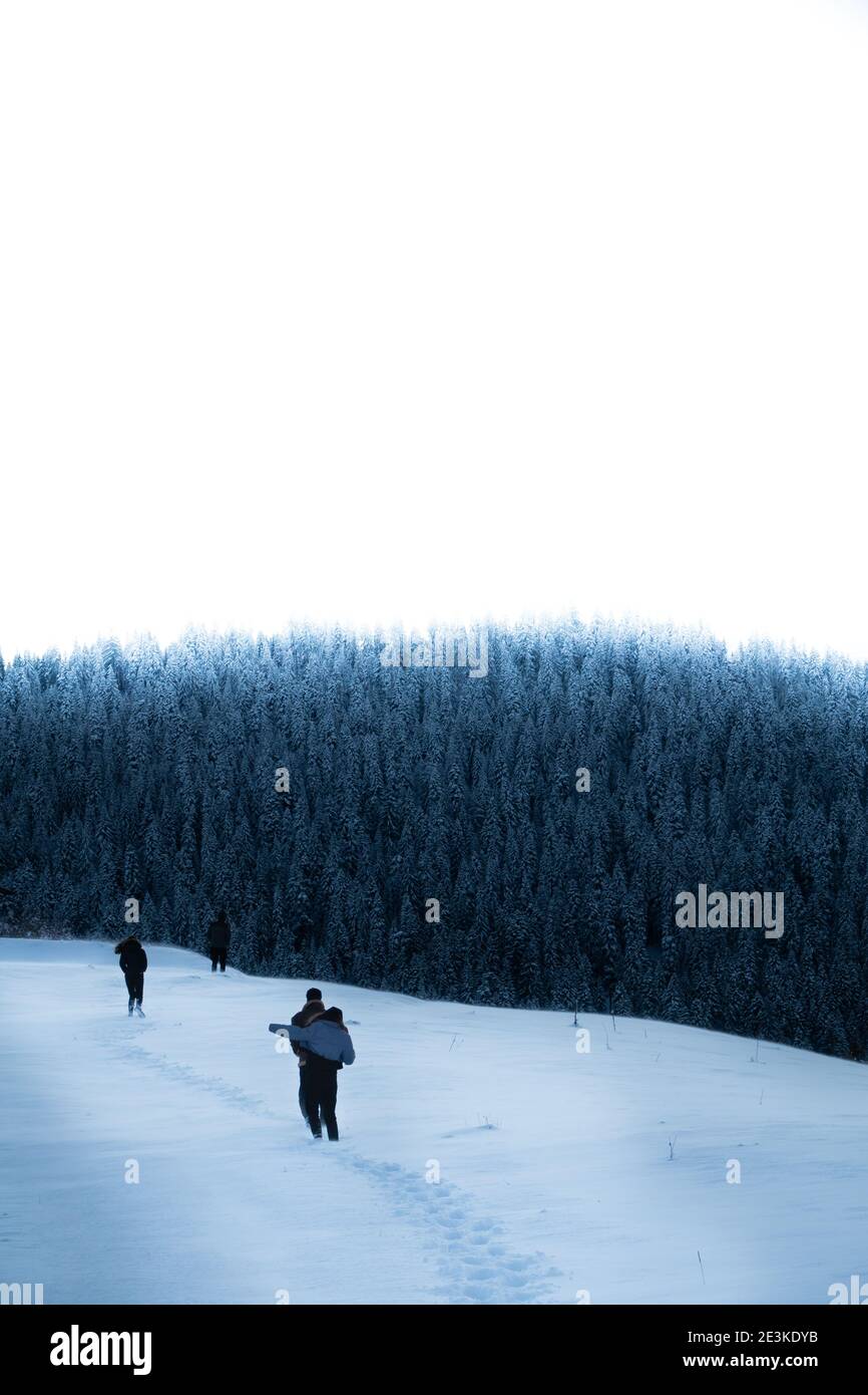 People walking trough the snow Stock Photo - Alamy