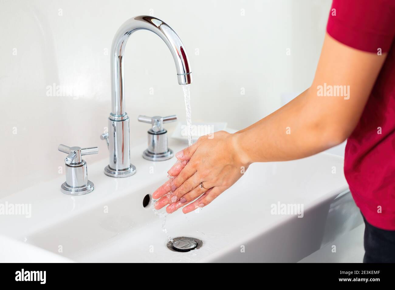 Washing hands under running water in washbasin from close up Stock ...