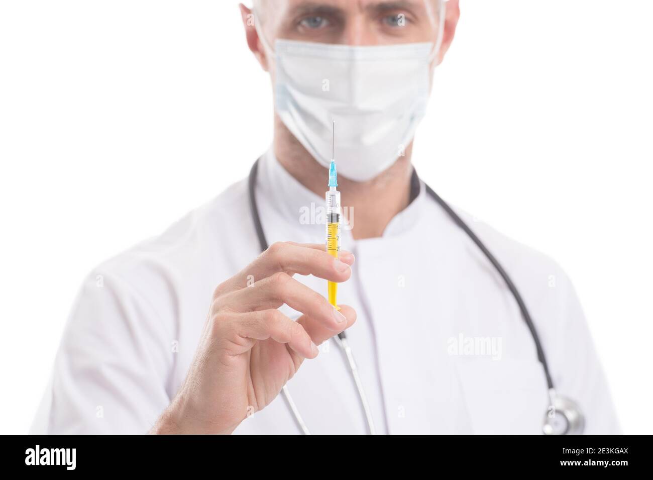 Drug delivery gets smarter. Doctor in medical mask hold syringe. Giving ...