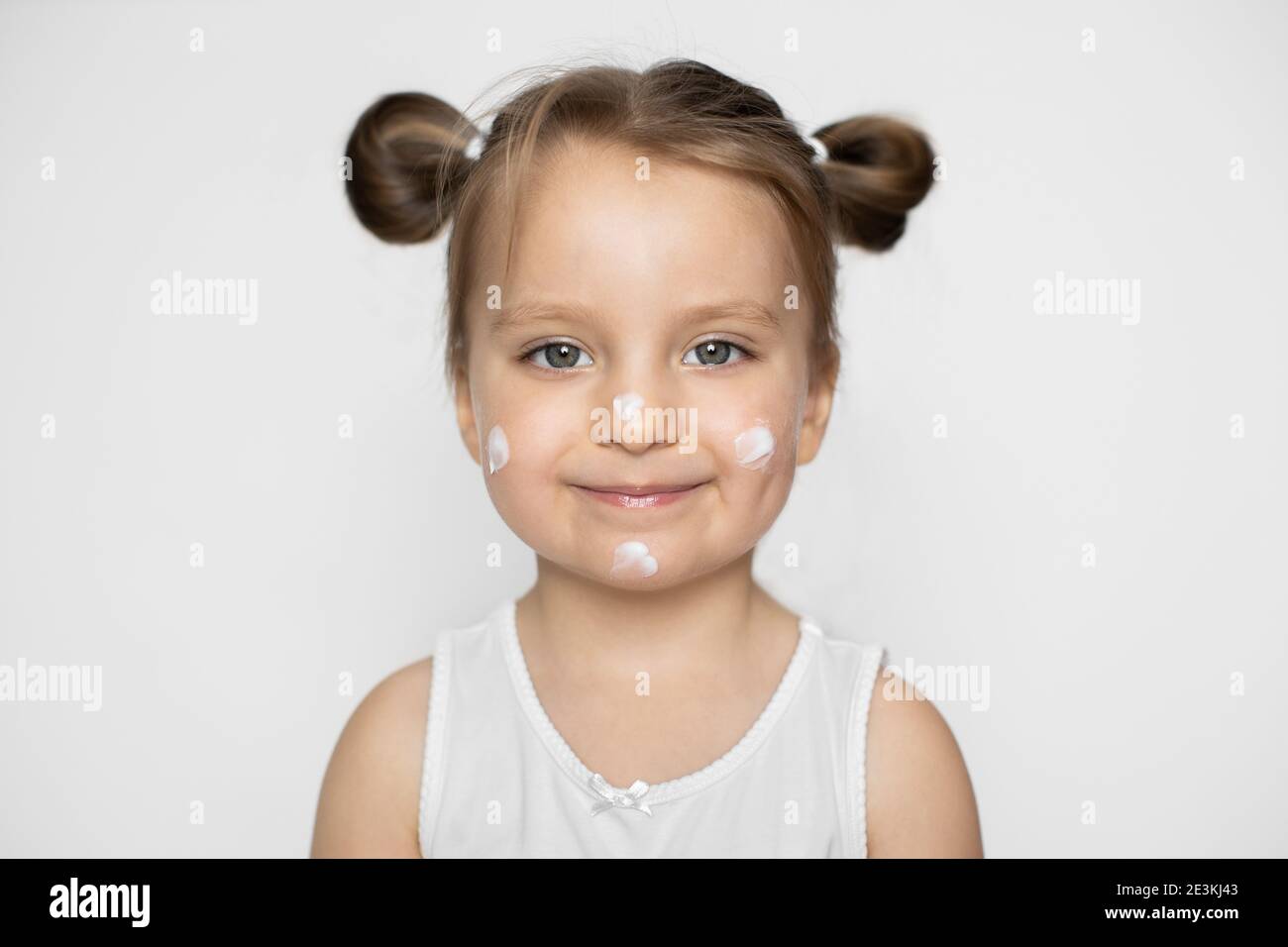 Close up of funny cheerful little 3 years old blond haired Caucasian ...