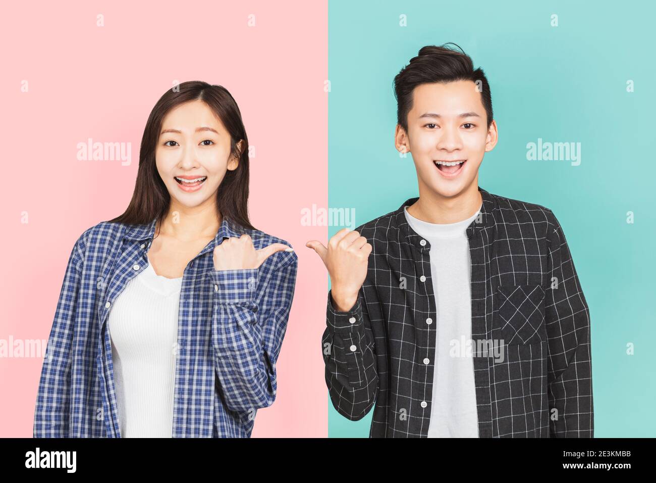 smiling young asian couple hand pointing finger on each other Stock ...