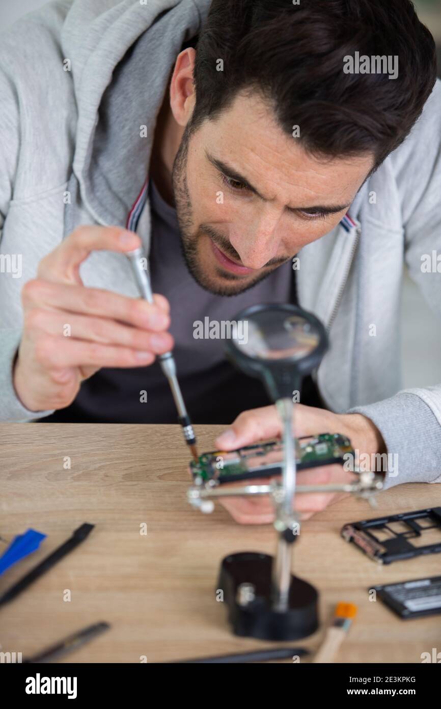 young man repairing motherboard from pc Stock Photo - Alamy