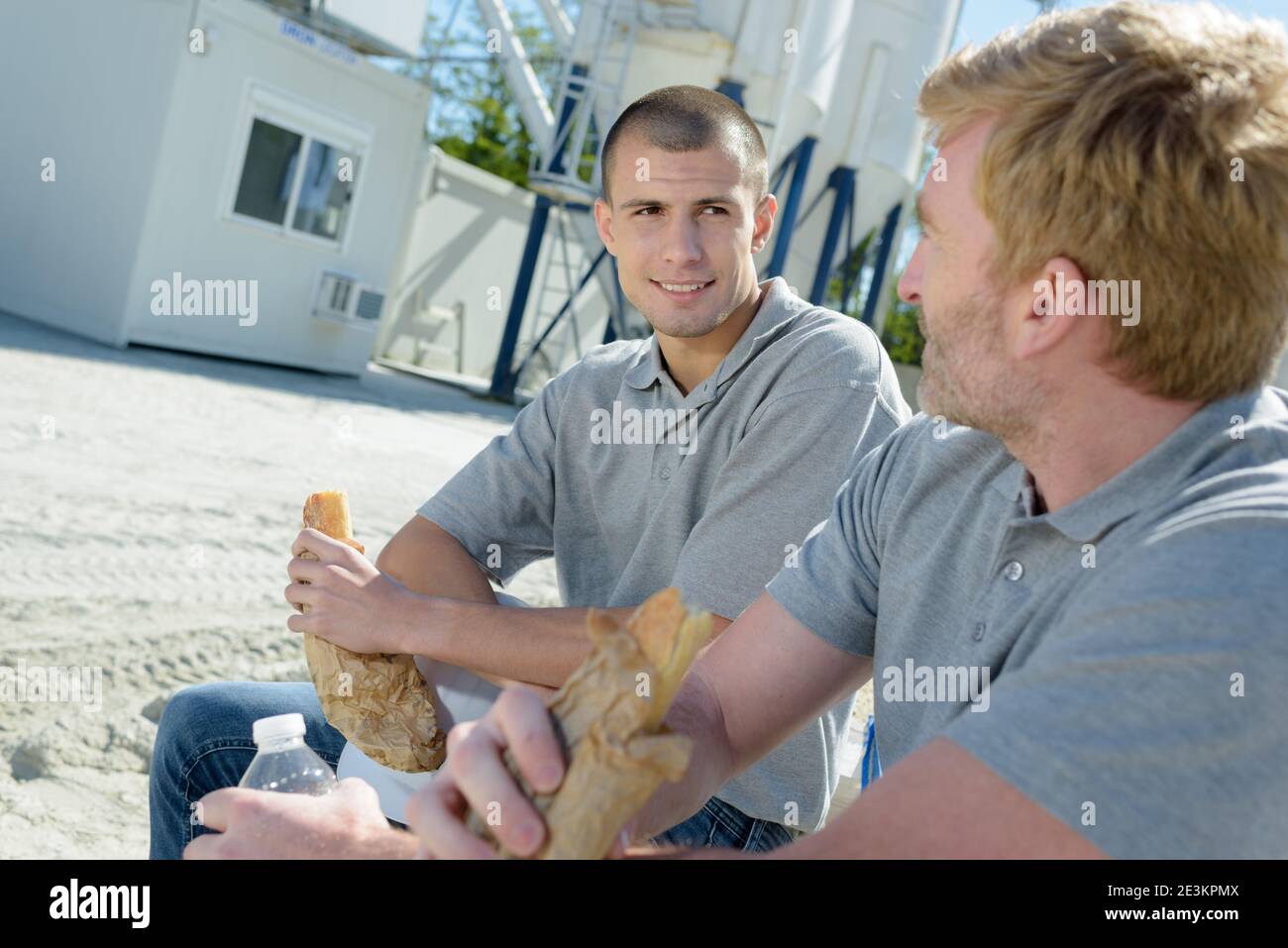 two builders having lunch outdoors Stock Photo - Alamy