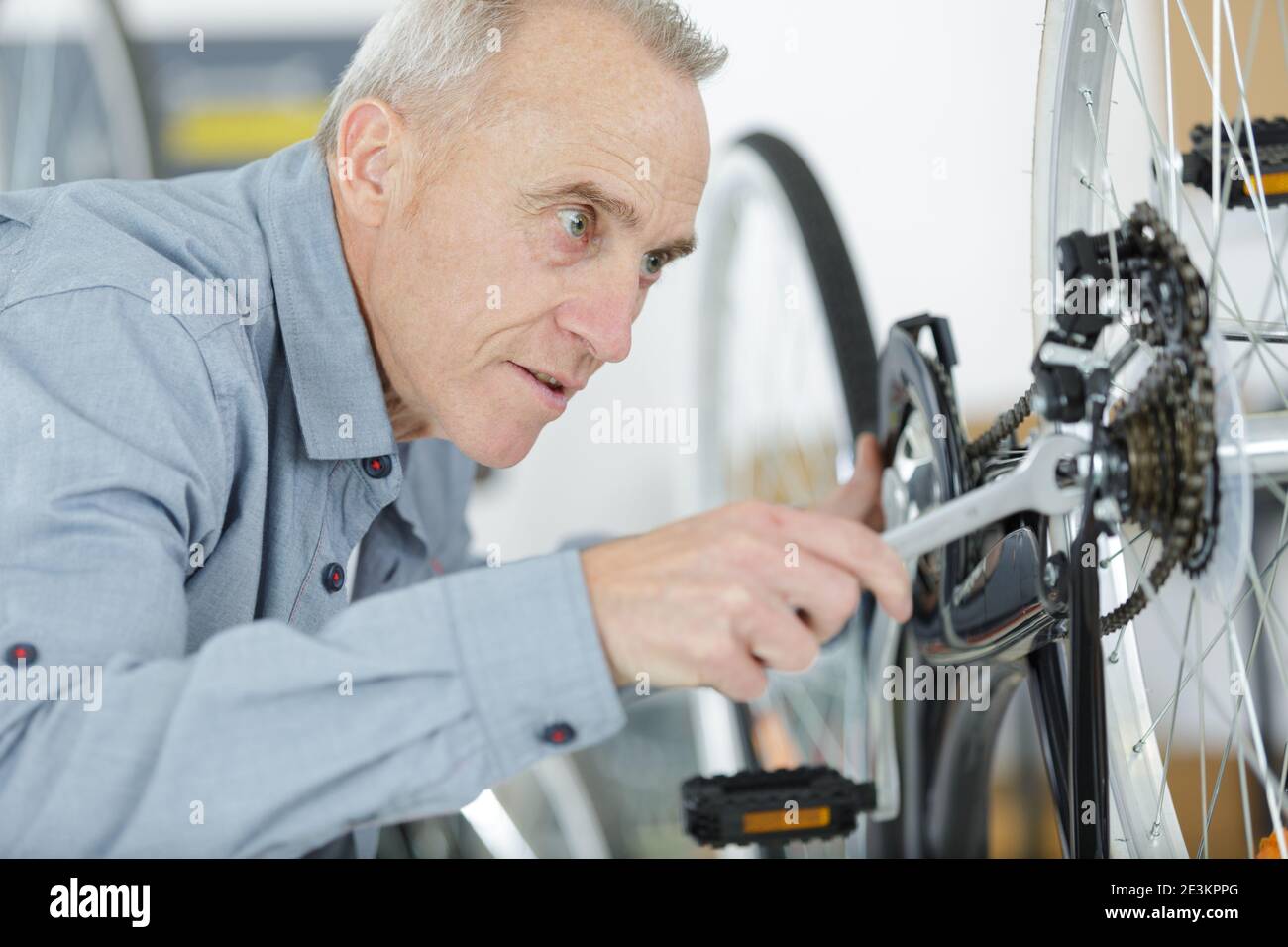 senior man fixing a bike problem Stock Photo - Alamy