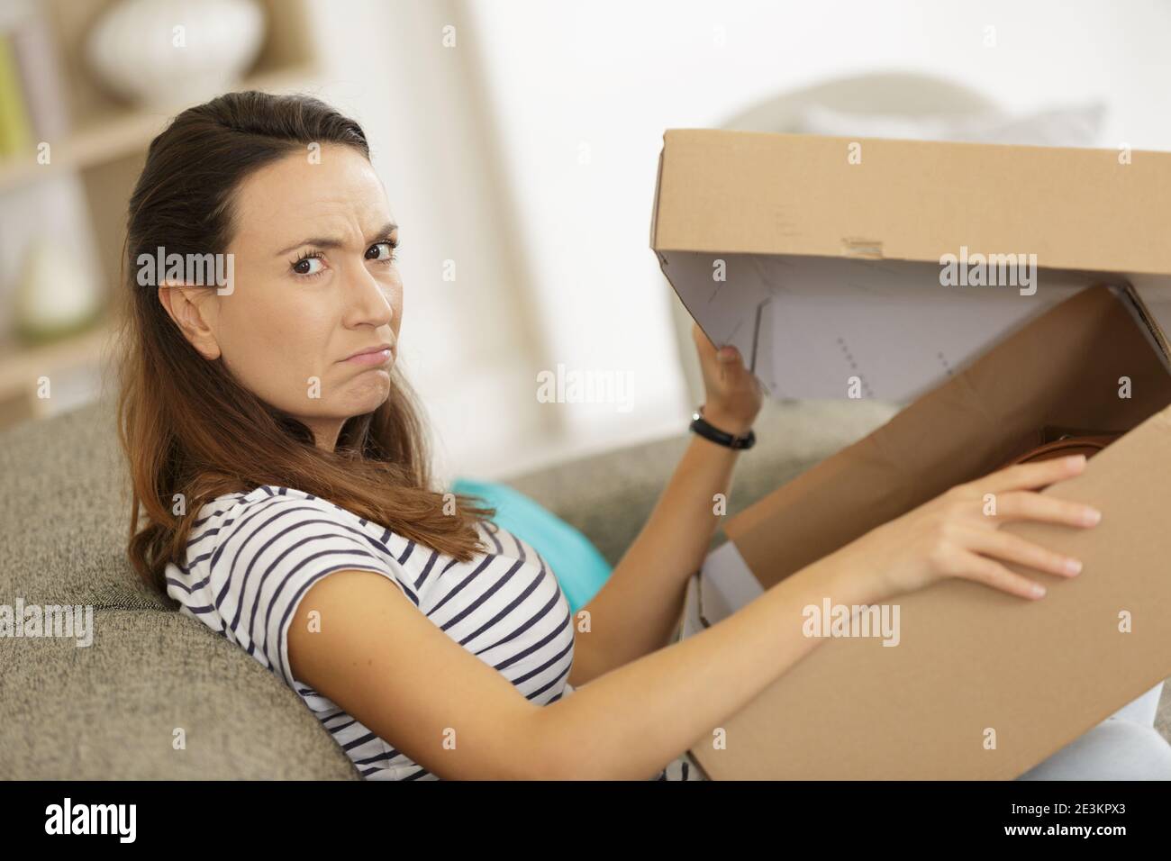 woman not sure about the box Stock Photo - Alamy