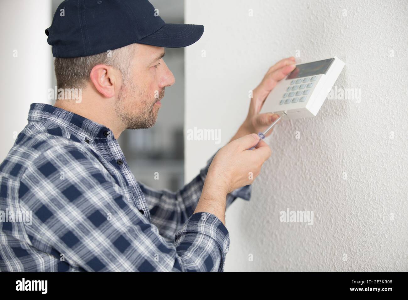 an electrician installing alarm system Stock Photo - Alamy