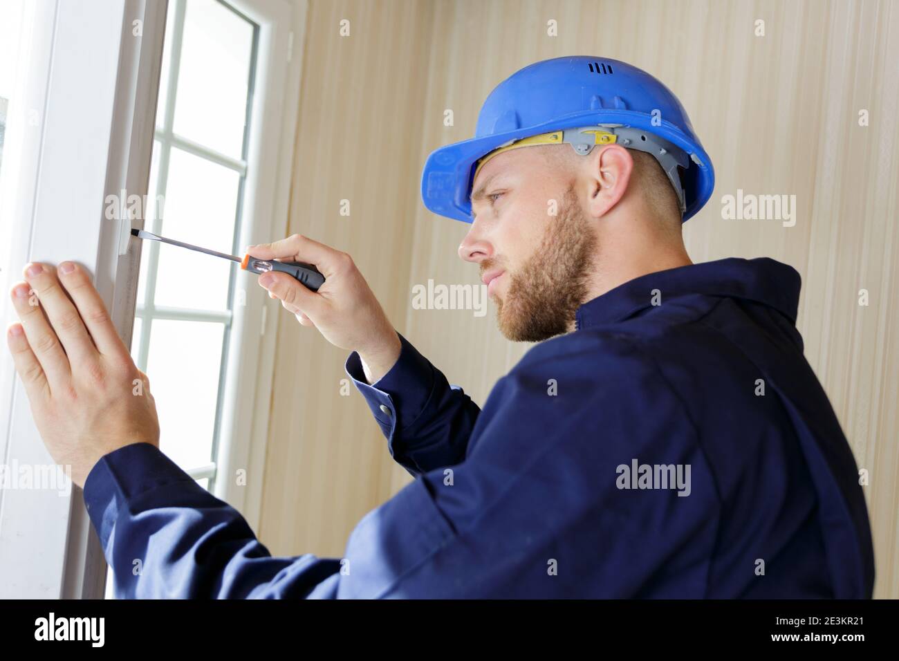 builder man engineer fixing a window Stock Photo - Alamy