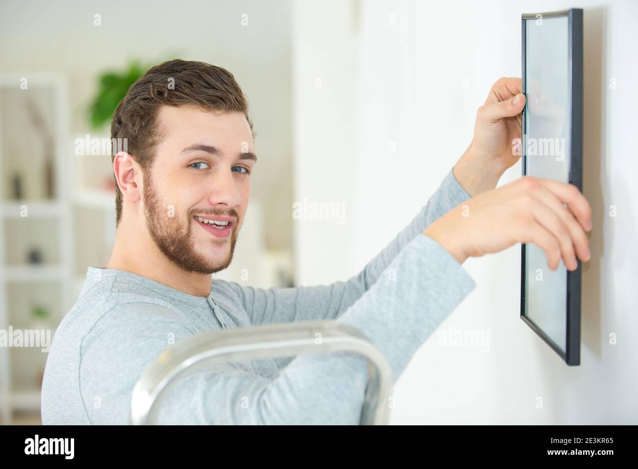 Putting up picture hi-res stock photography and images - Alamy