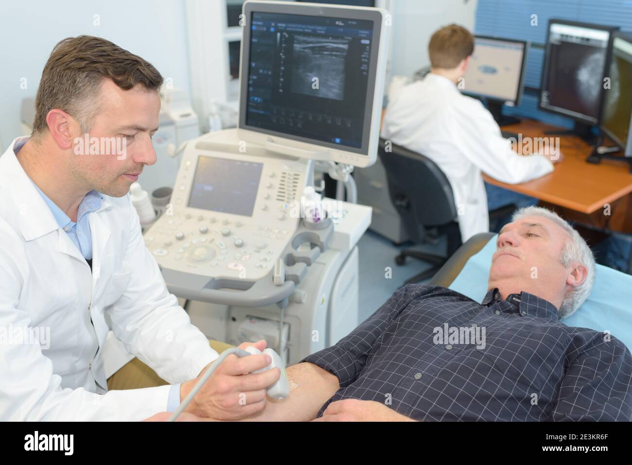 doctor performing ultrasound on male patients arm Stock Photo - Alamy