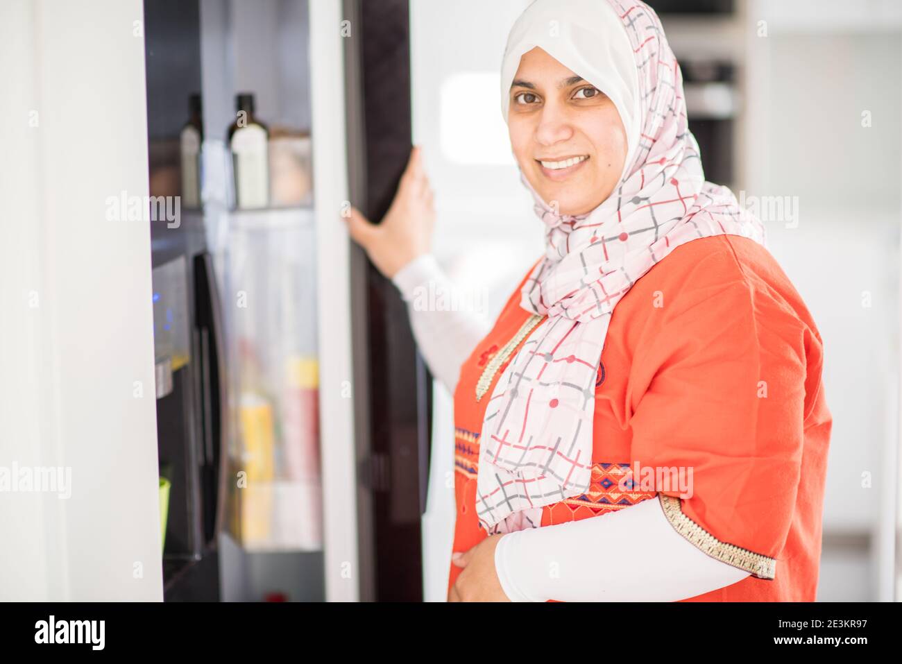 Muslim Arabic traditional woman in kitchen preparing food for lunch ...