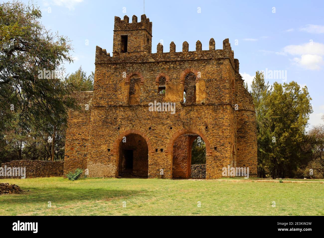 Arched doors and windows and a scalloped roofline decorate the exterior ...