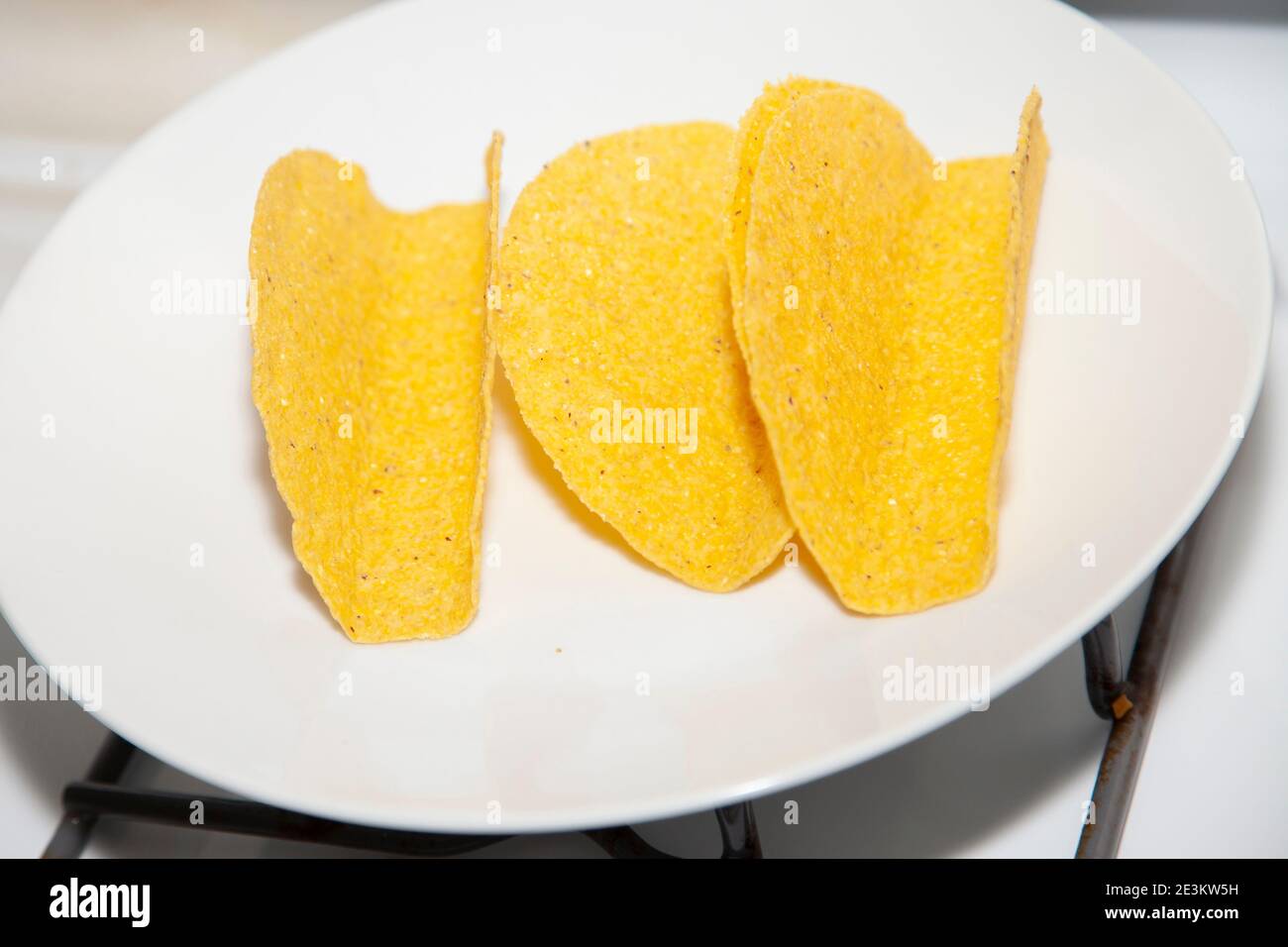 Three empty corn taco shells on a white plate Stock Photo - Alamy