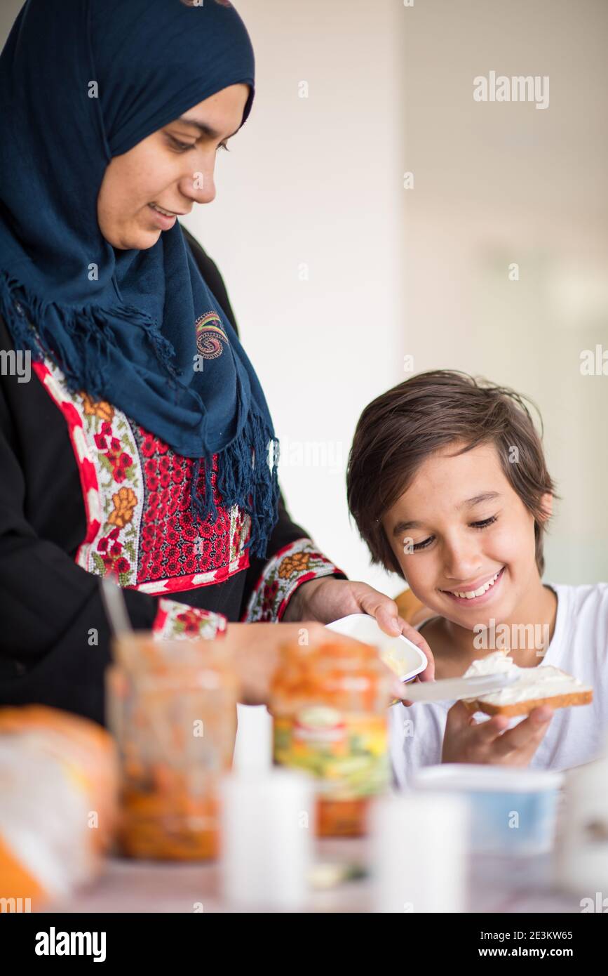 Muslim traditional woman with son at kitchen Stock Photo - Alamy