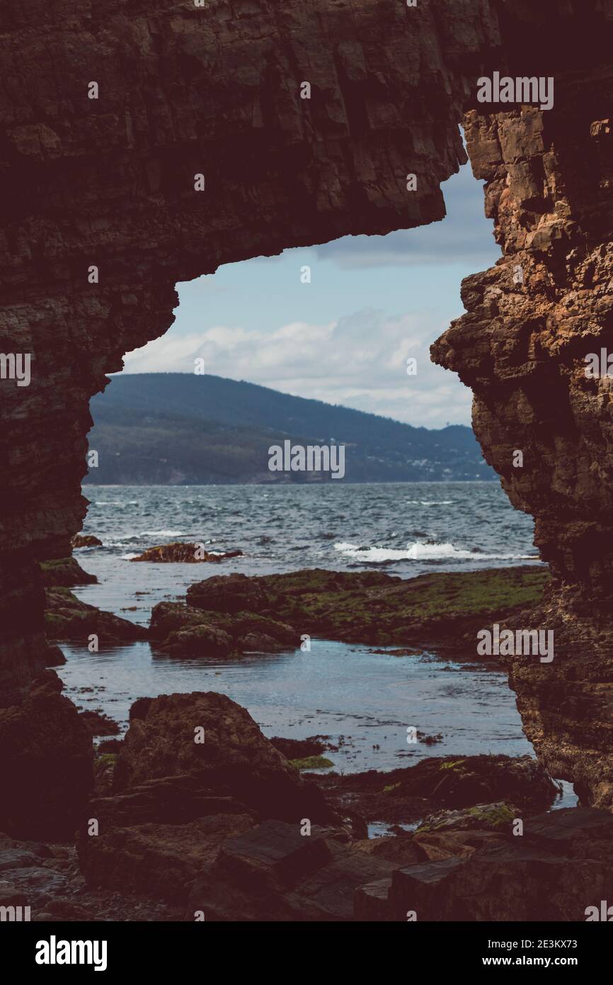 wild Tasmanian landscape with rocky shores and calm Southern Ocean ...
