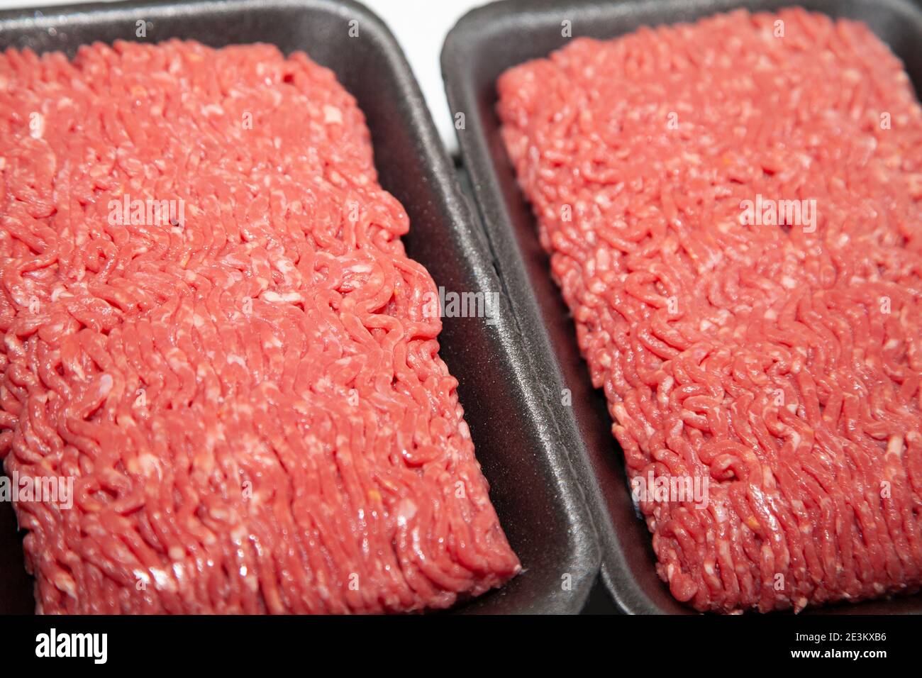 Two open packages of ground angus beef on a stove Stock Photo - Alamy