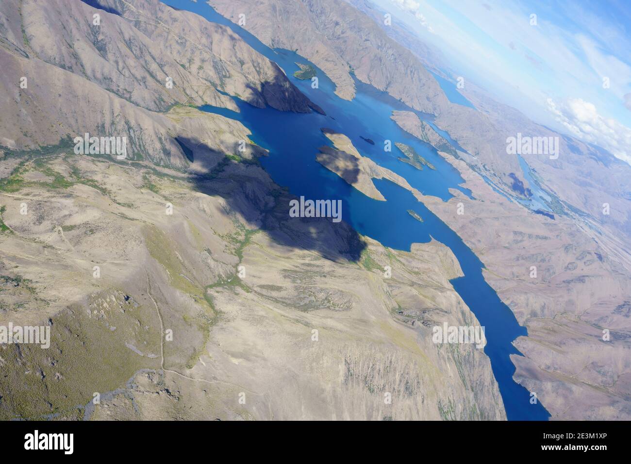Aerial view of bright blue Lake Benmore in Canterbury landscape through ...