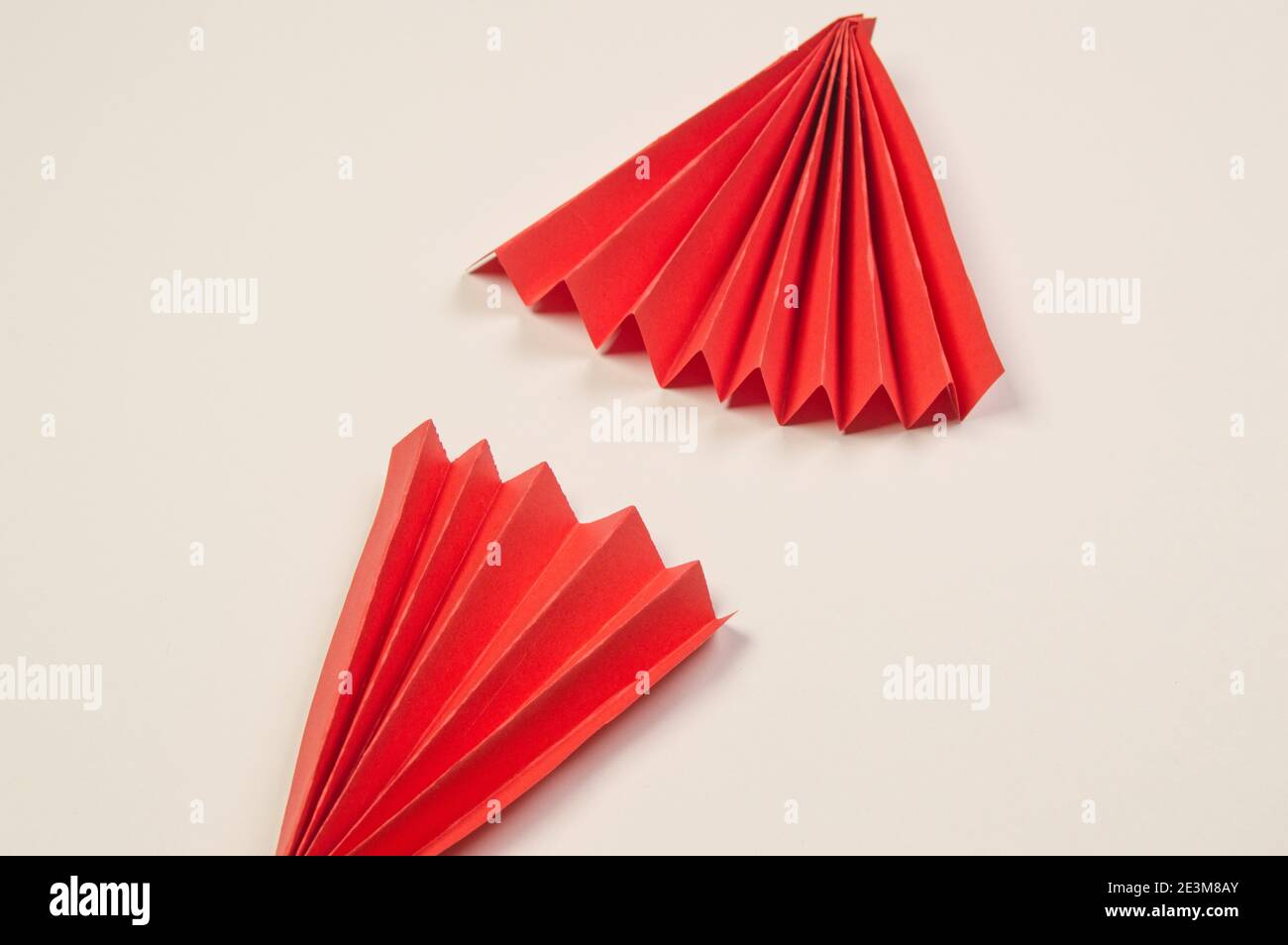 Two red origami paper fans, on a white background, copy the space Stock ...