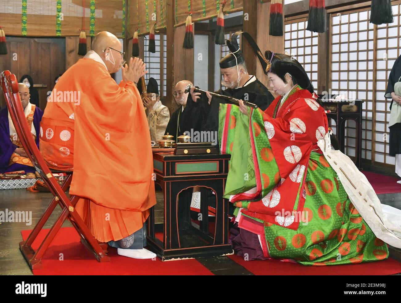 A couple (R) wearing traditional Japanese attire take part in a ritual ...