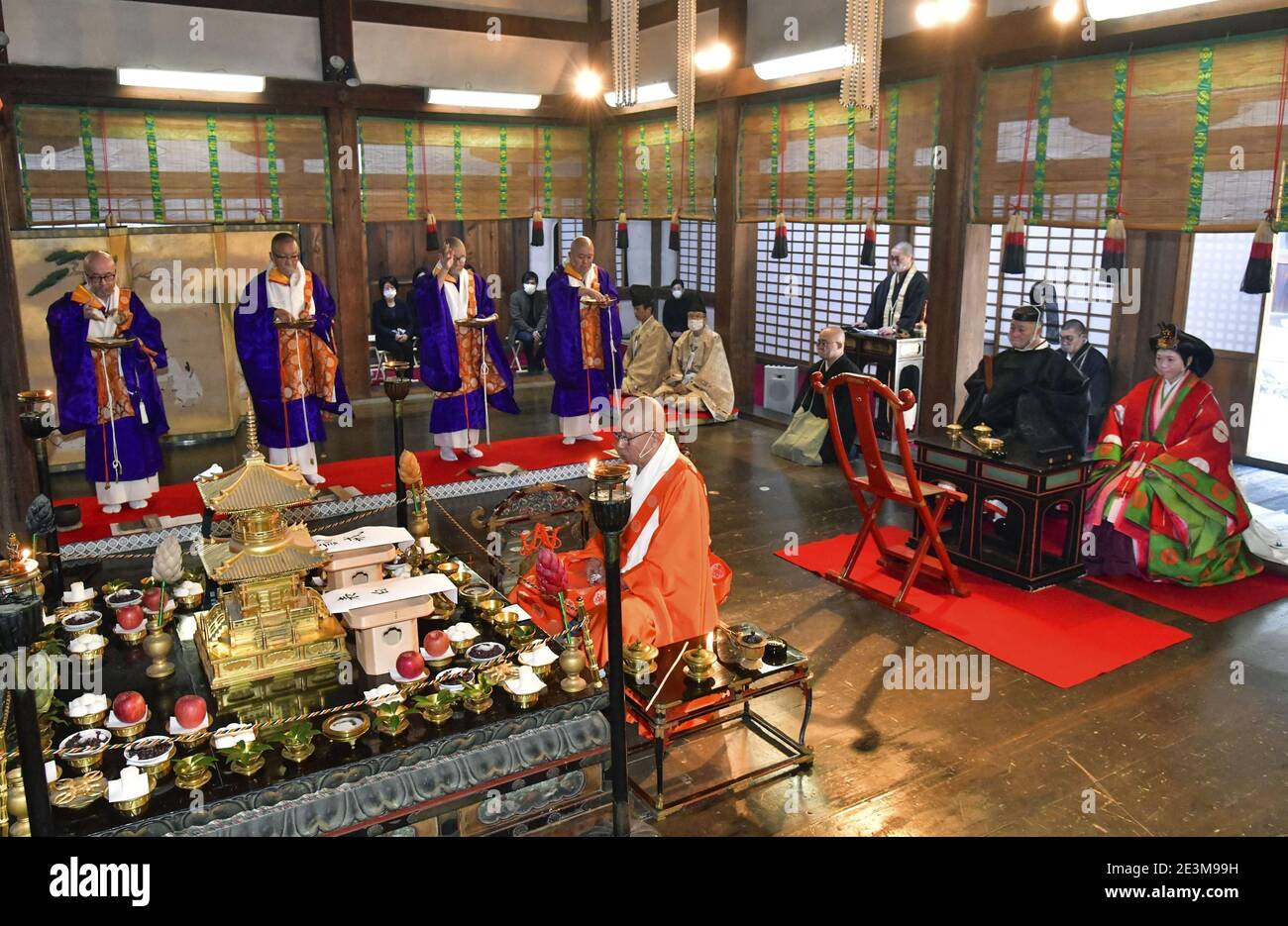 A couple (R) wearing traditional Japanese attire take part in a ritual ...