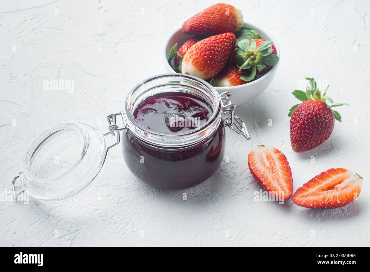 Natural strawberry jam jar, on white background Stock Photo - Alamy