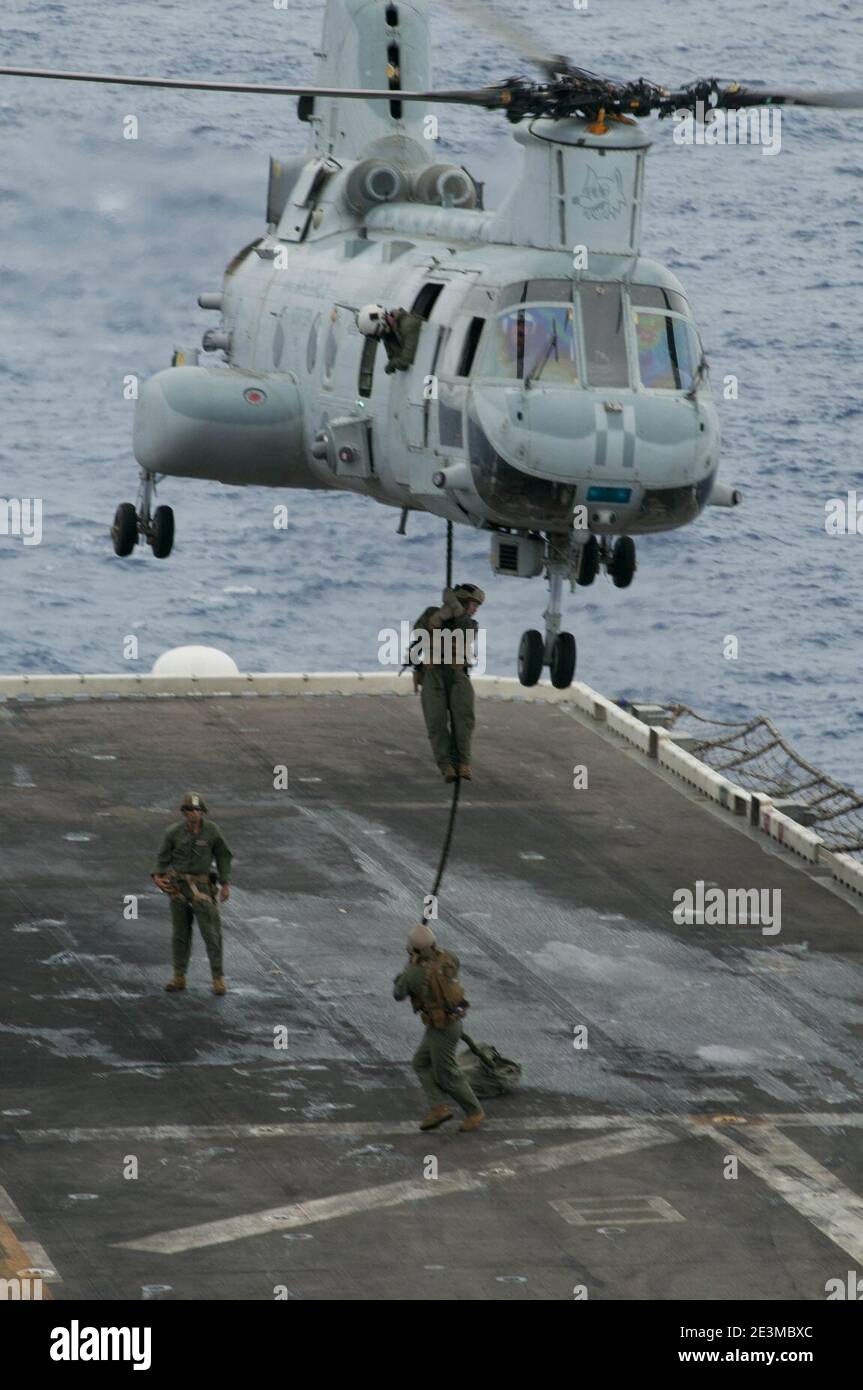 Marines fast rope onto flight deck of USS Peleliu 121005 Stock Photo ...