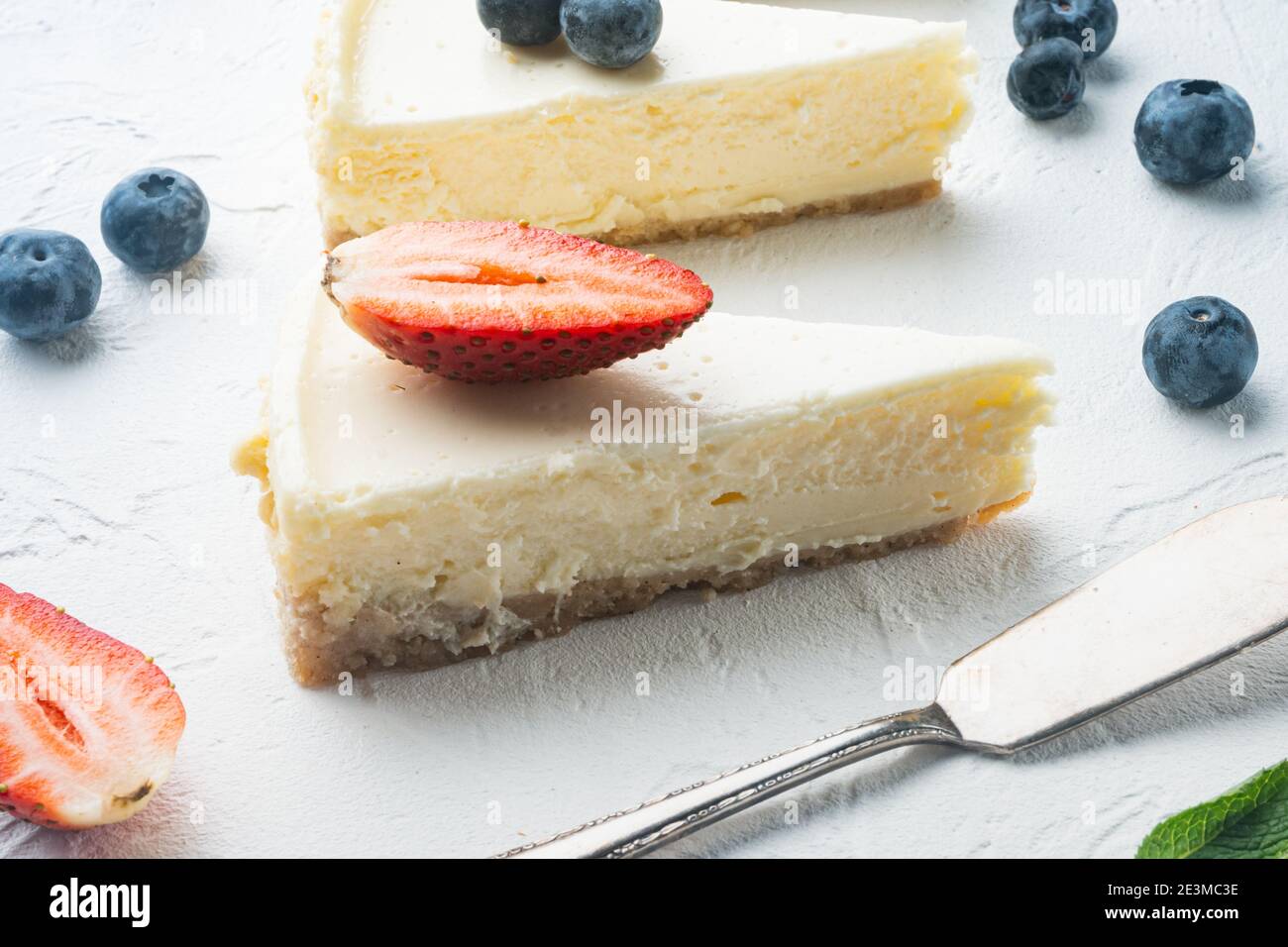 Portion of cheesecake with berrie, on white background Stock Photo - Alamy
