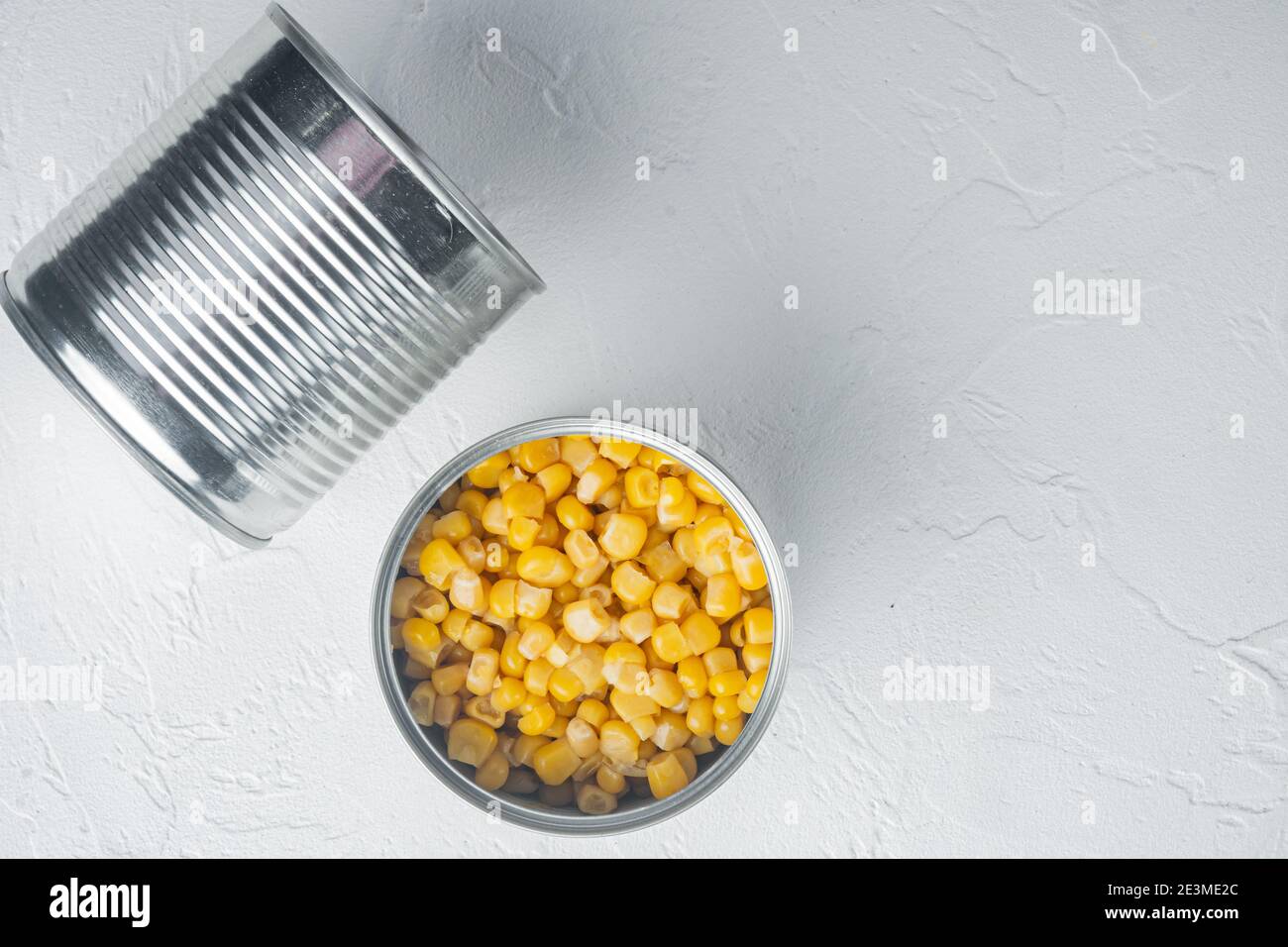 Canned corn in can, on white background, top view flat lay with copy ...