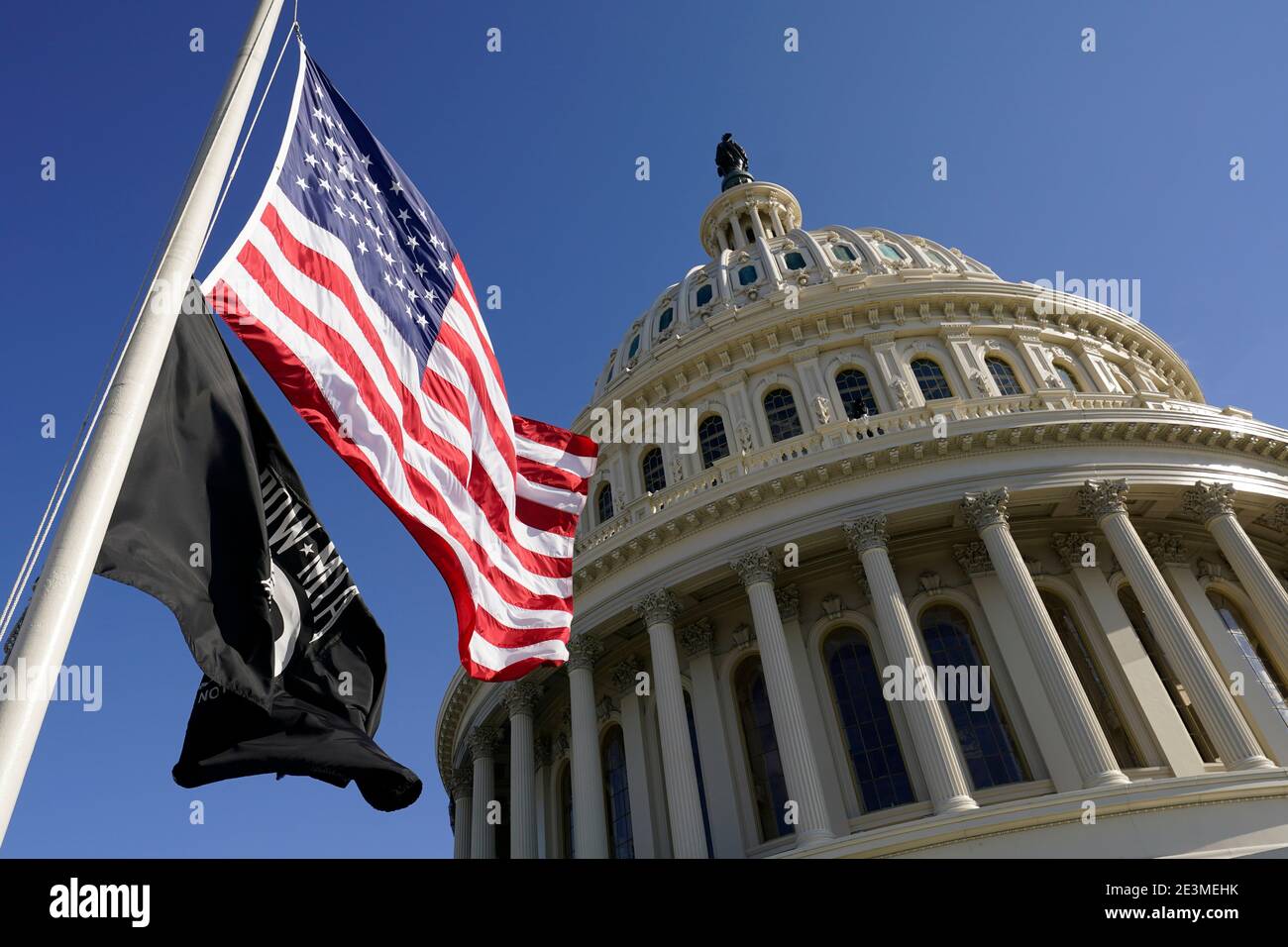 Flags fly on the U.S. Capitol in Washington, Tuesday, Jan. 19, 2021 ...