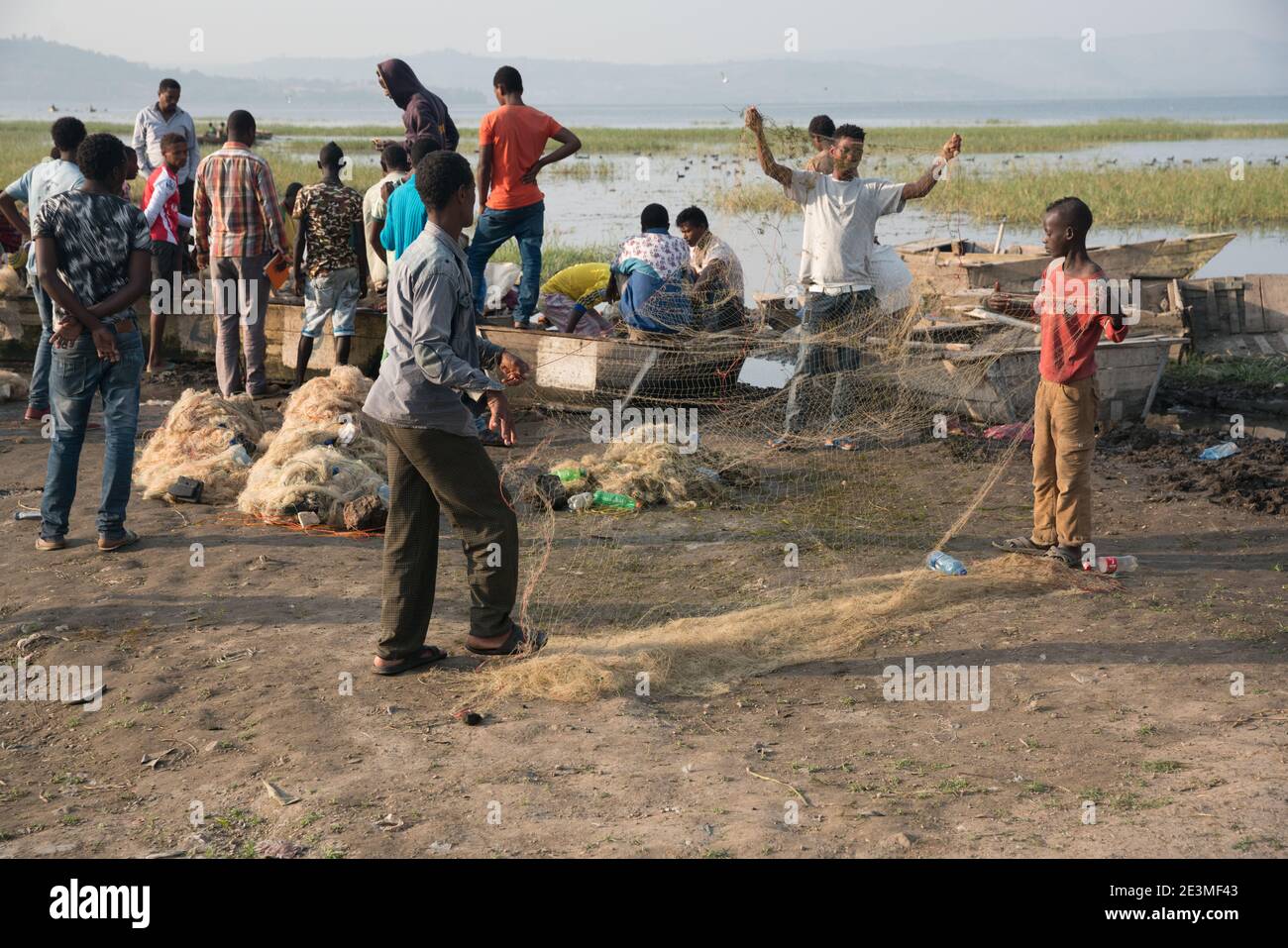 The Fish Market at Lake Awasa: Men and boys detangle fishing nets Stock ...