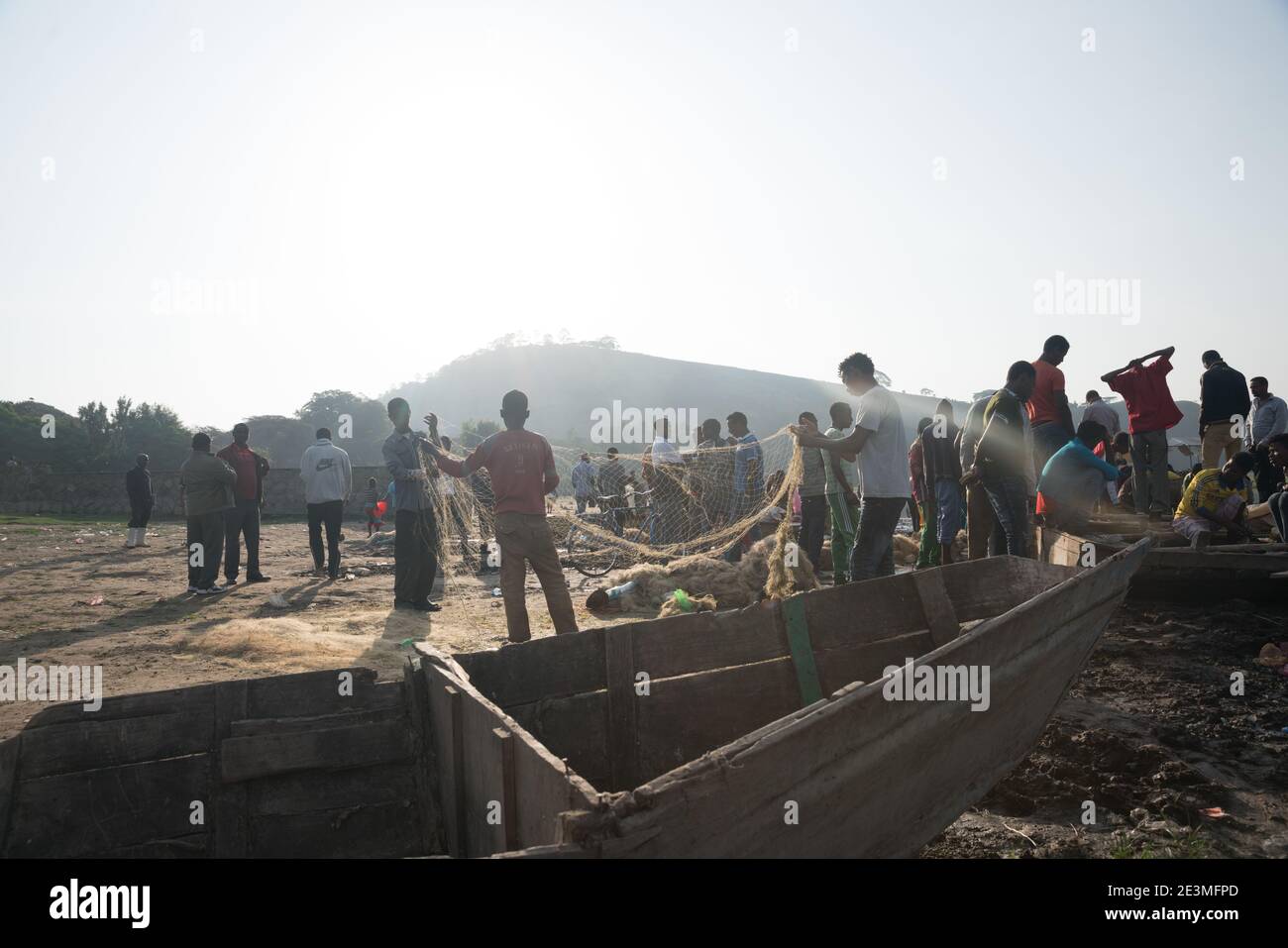 Fish Market at Lake Awasa : Young men unravel and detangle fishing nets ...