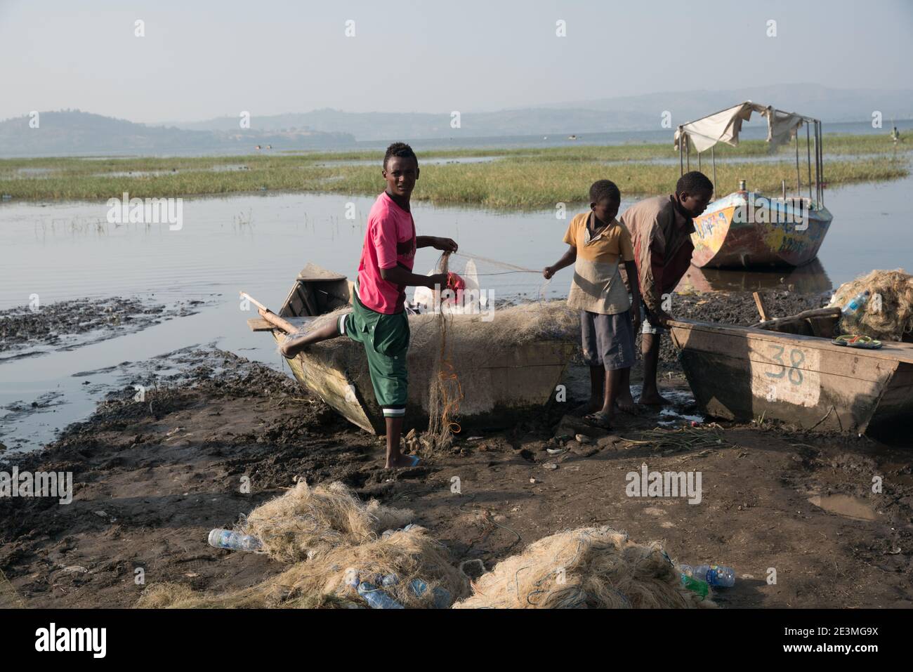 Fish Market at Lake Awasa: Young men unravel and detangle fishing nets ...