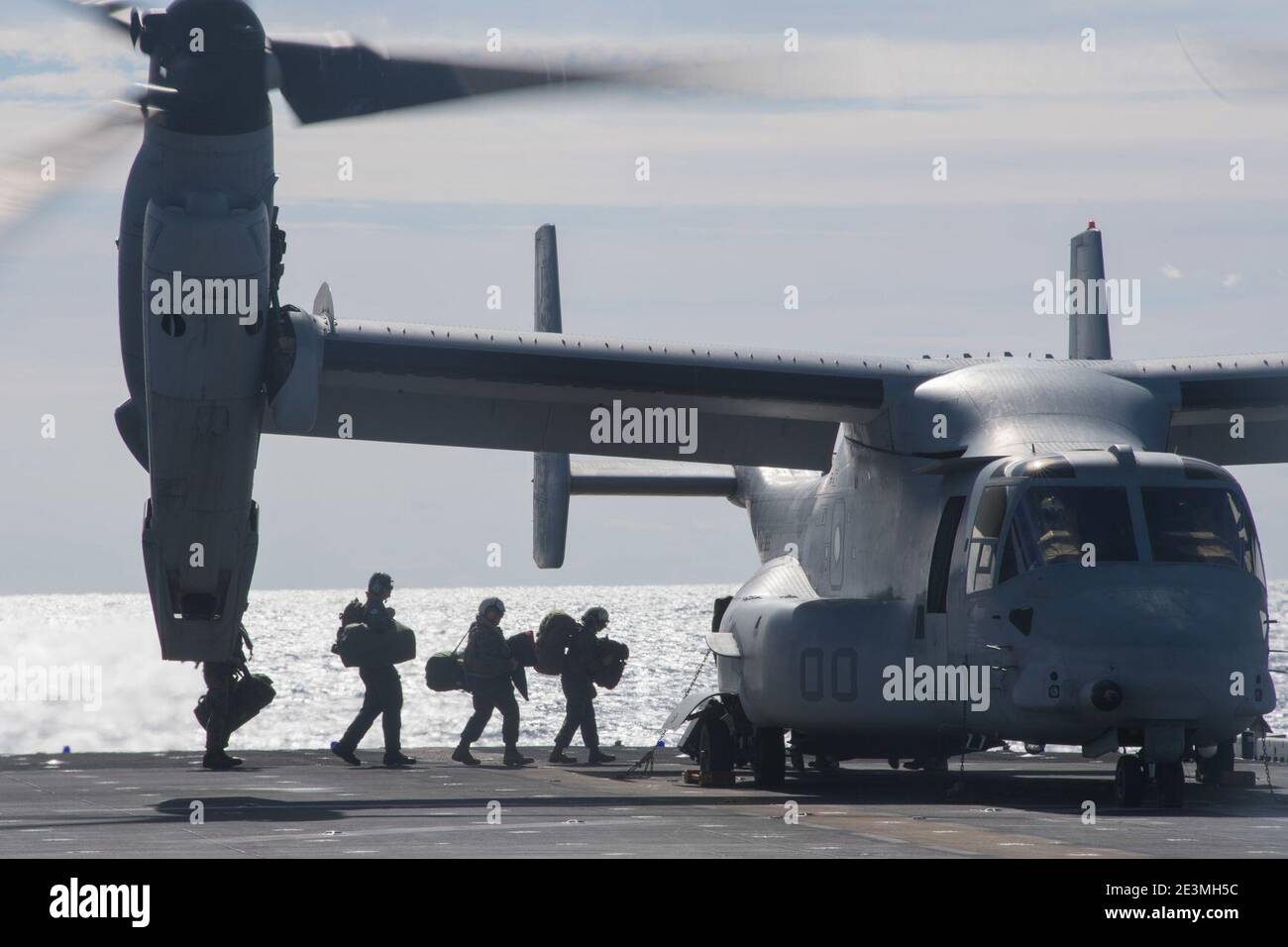 Marines board an MV-22 Osprey aircraft aboard the flight deck of USS ...