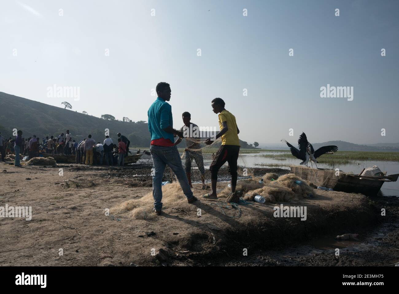 Fish Market at Lake Awasa : Men unravel and detangle fishing nets Stock ...