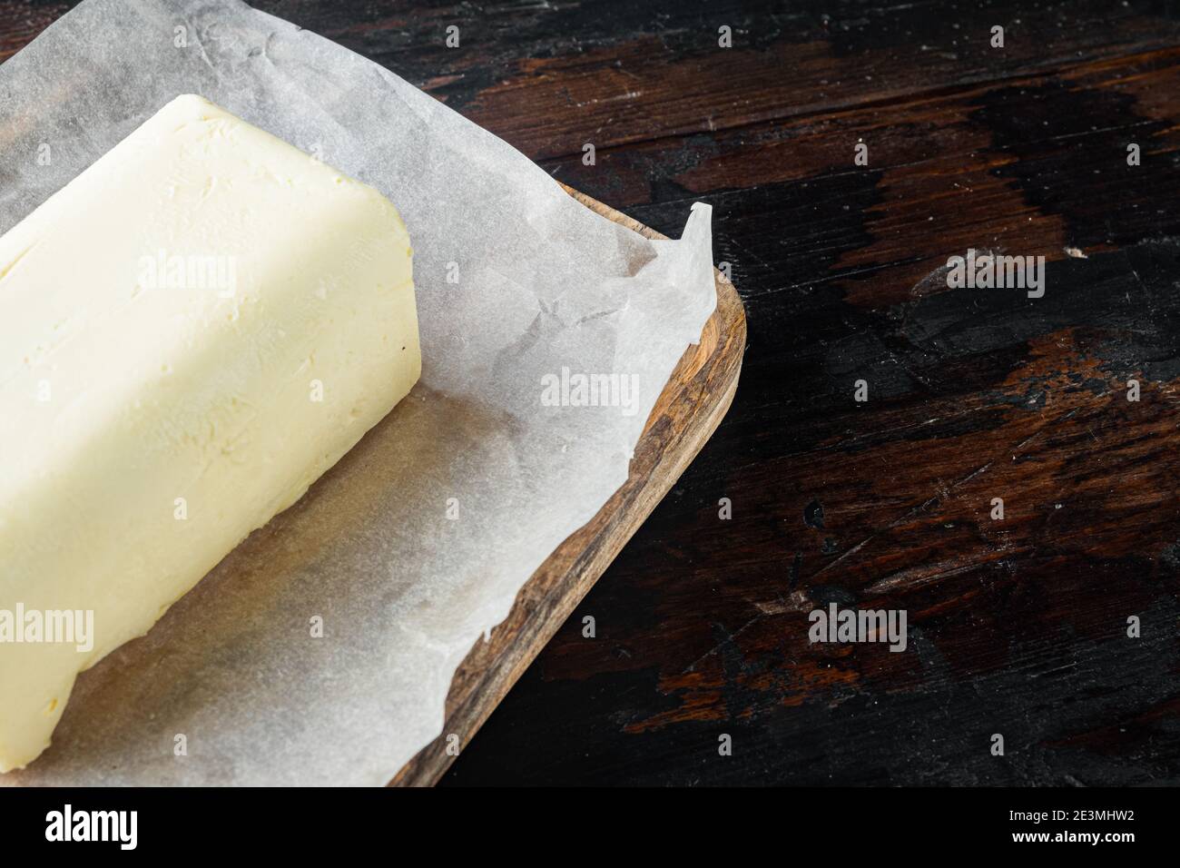 Fresh butter package, on old dark wooden table background with copy ...