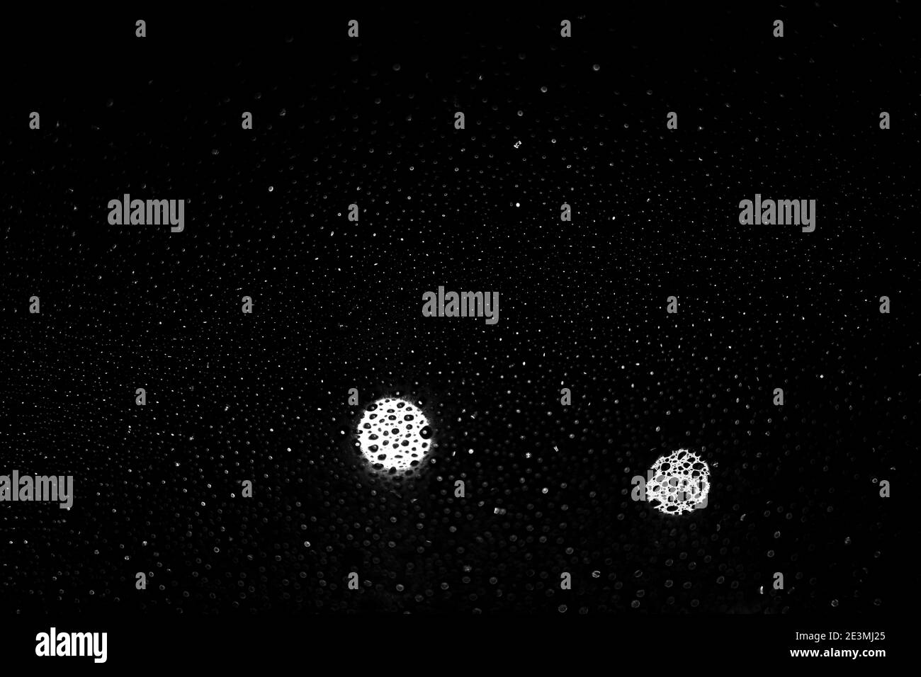 Water drops rain drops on the windshield of a car at night on black ...