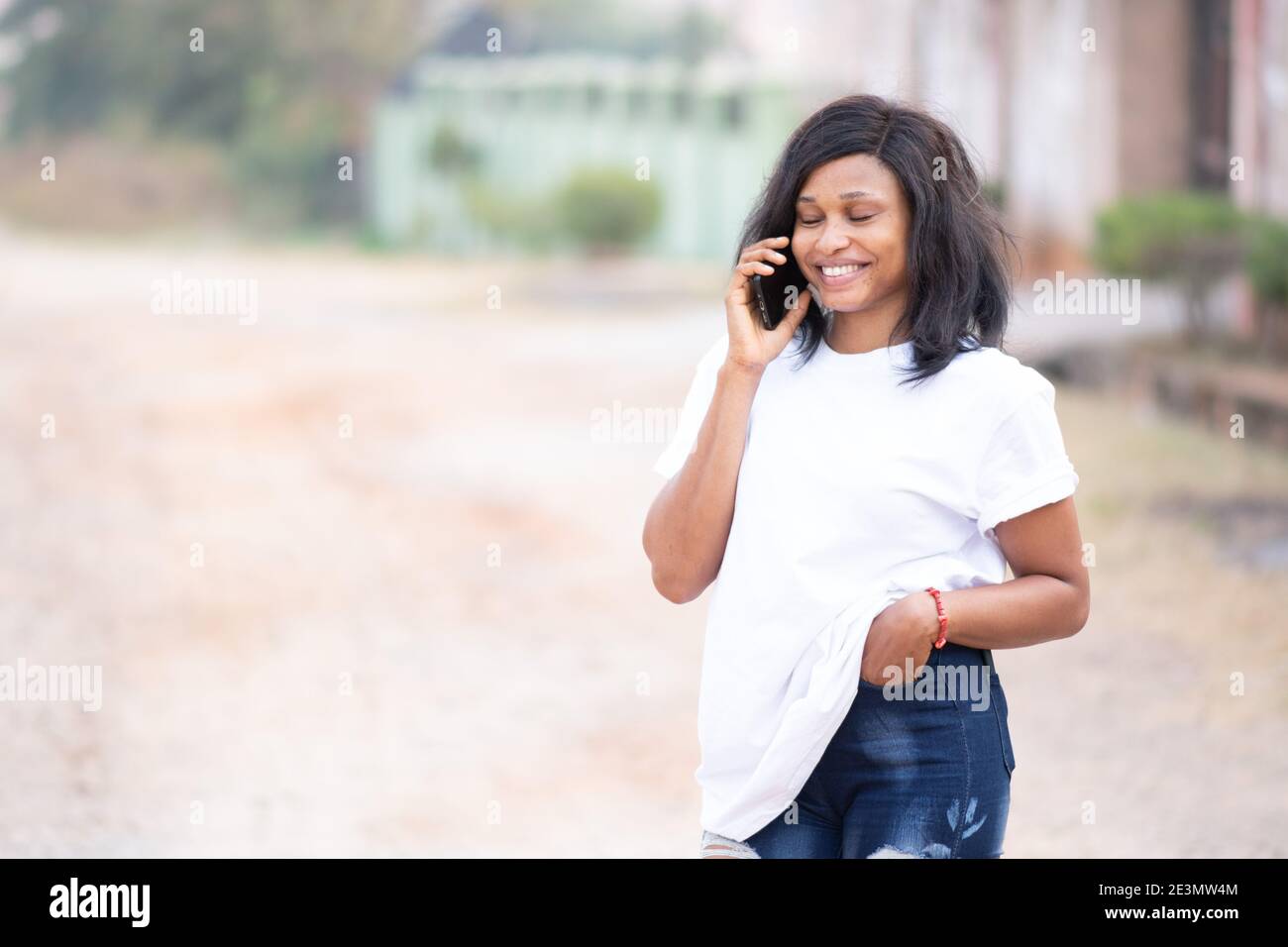 pretty young light skin african woman smiling with eyes closed while ...