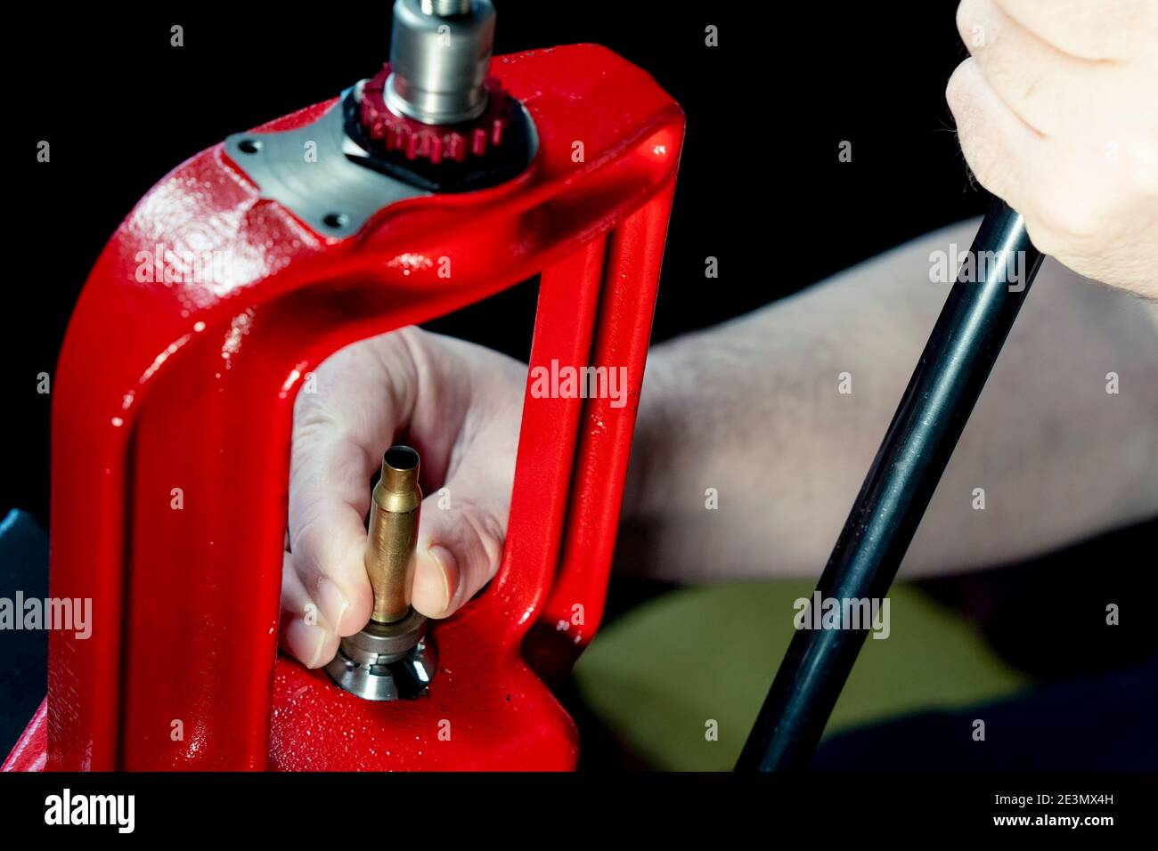 Red hand press and ammo shell against dark background, soft focus. Copy ...