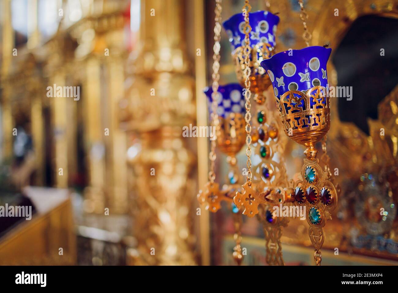 Lighting candles in a catholic temple . Candles are lit near the altar ...