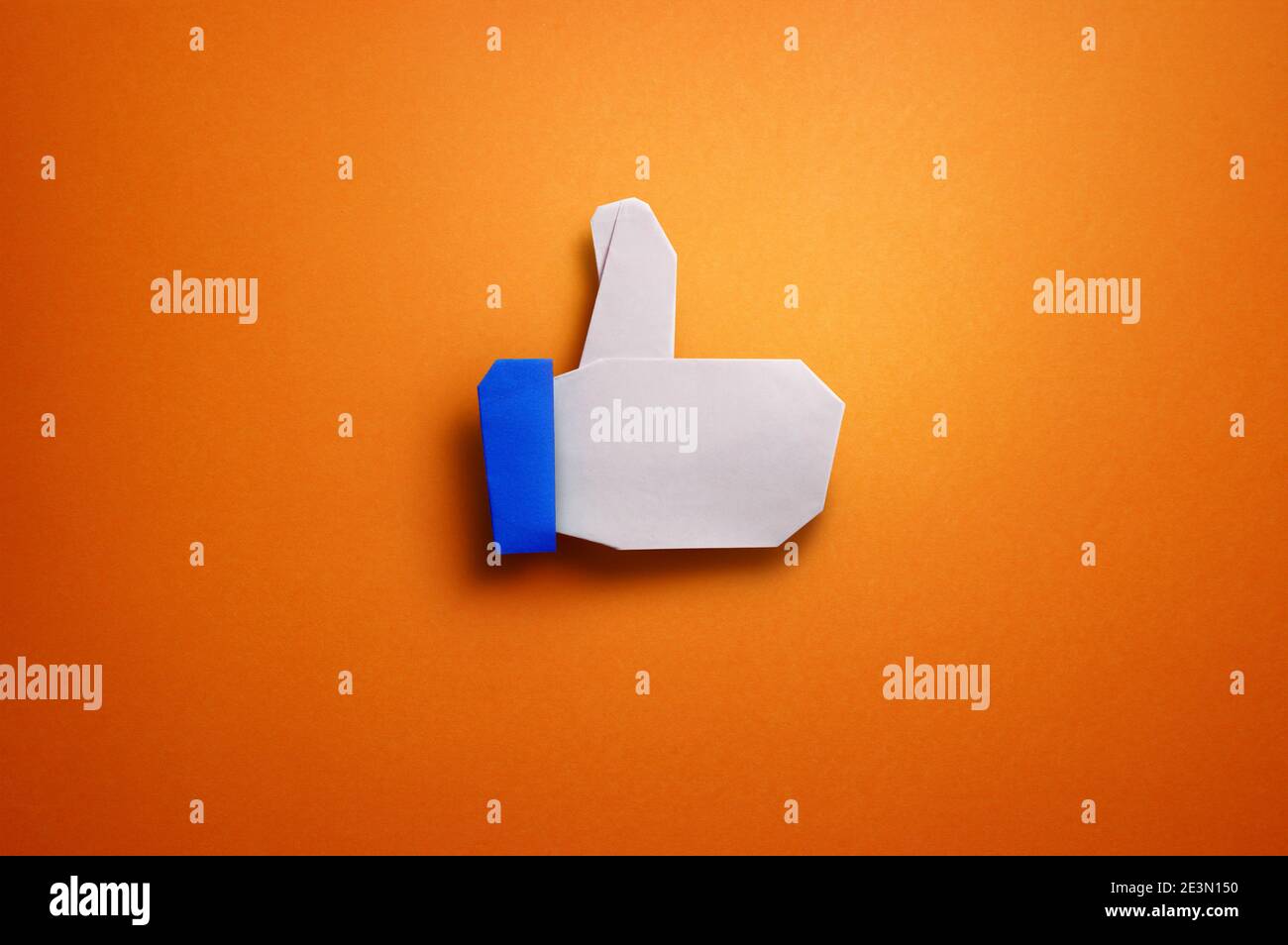 Origami thumbs up paper craft on orange background Stock Photo - Alamy