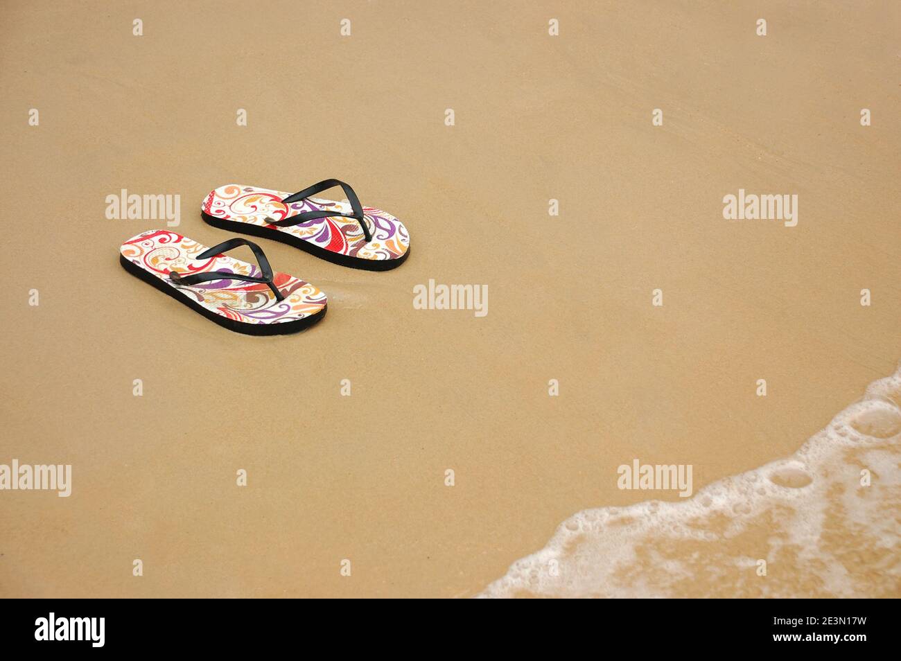 a pair of slipper on the beach sand Stock Photo - Alamy