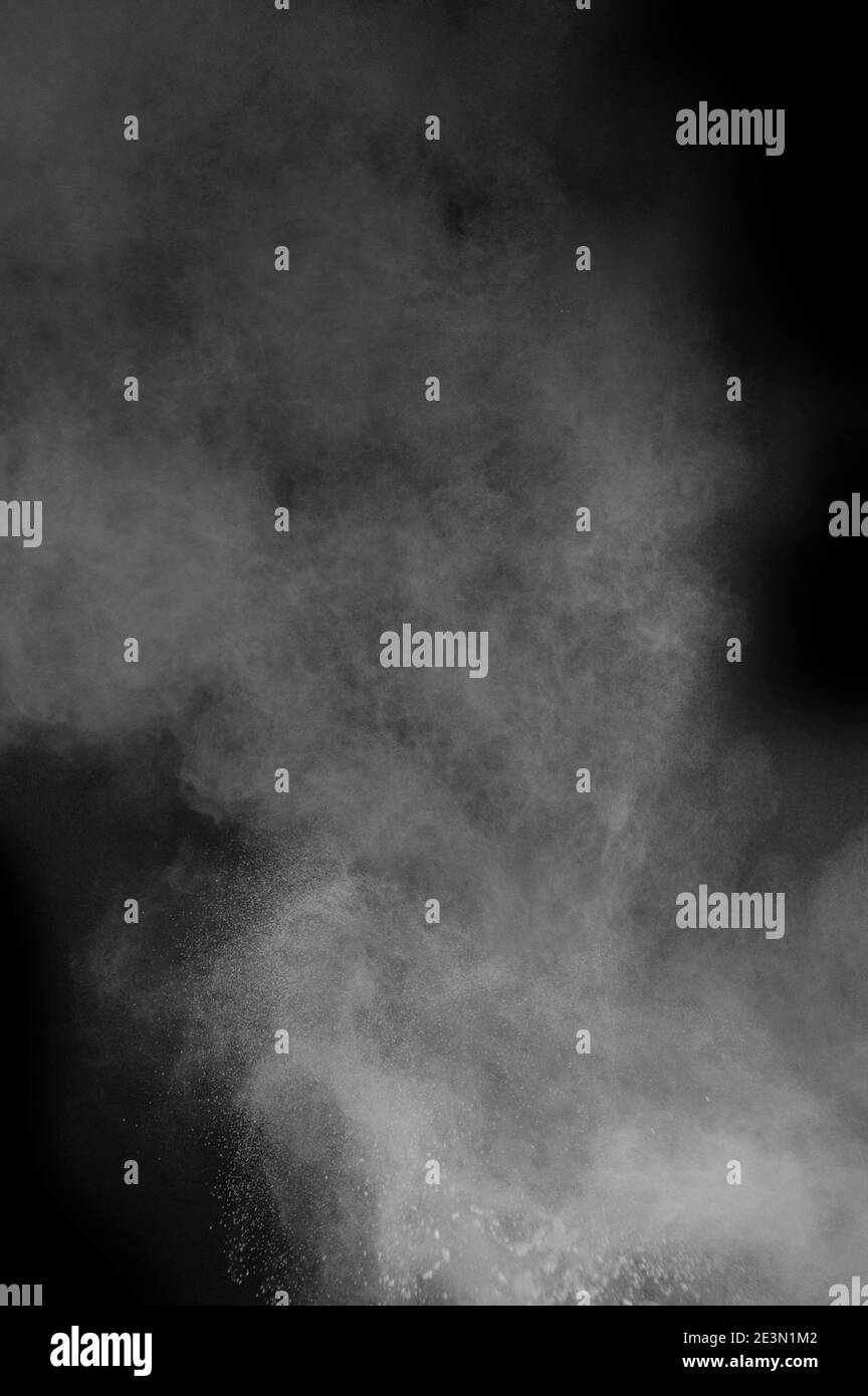 powder explosion with smoke on black background Stock Photo - Alamy