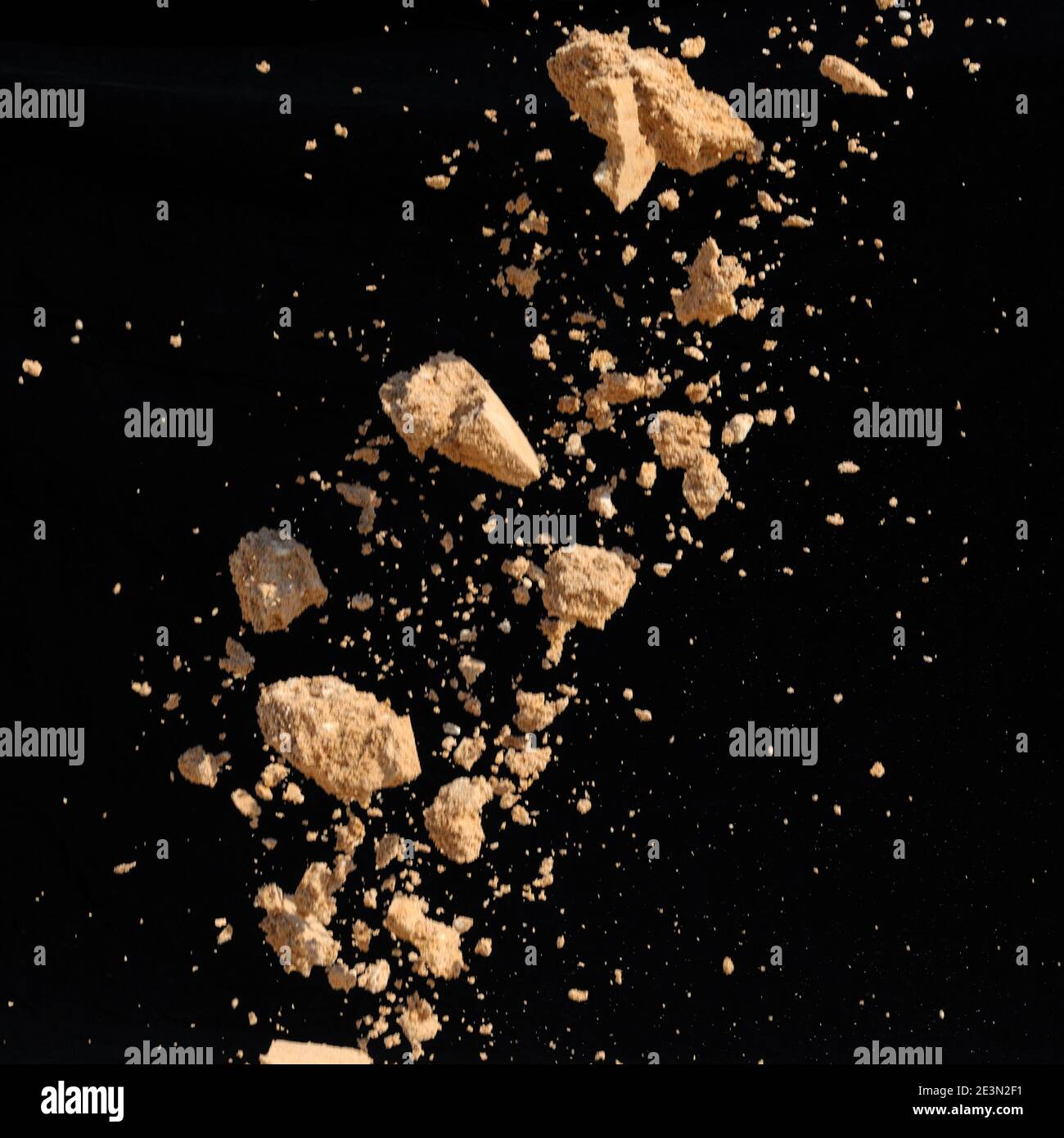 Pile of soil dropping isolated on black background Stock Photo - Alamy