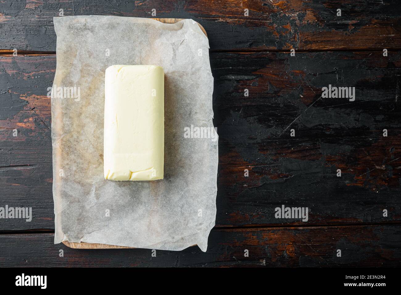 Dairy fresh butter, on old dark wooden table background, top view flat ...