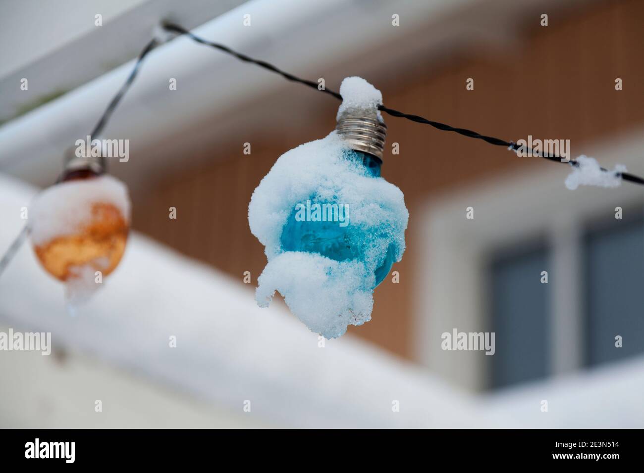 colored lights that have become snow covered are controlled by sunlight ...