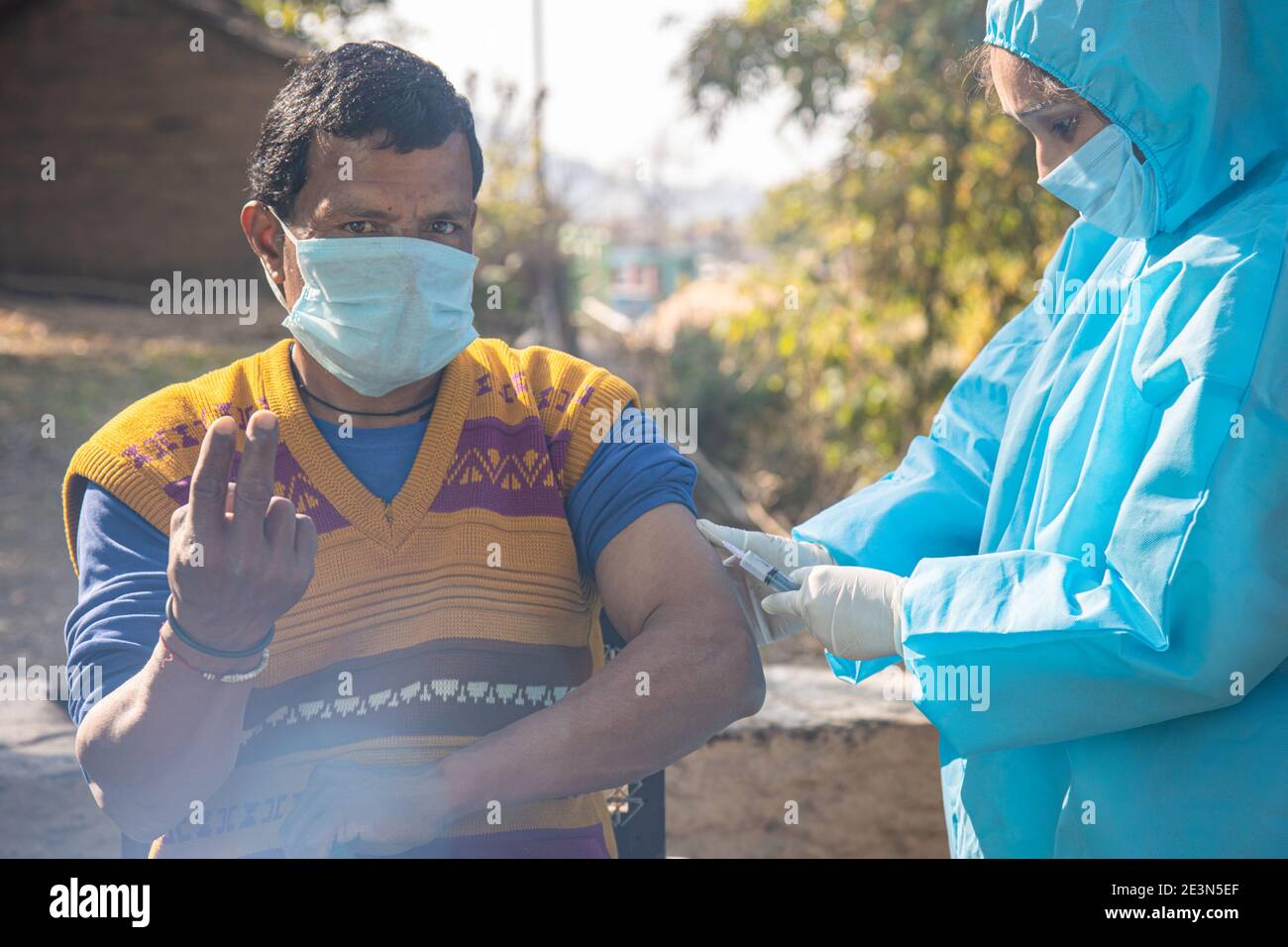 Female Nurse with PPE kit protective mask and gloves preparing a male ...