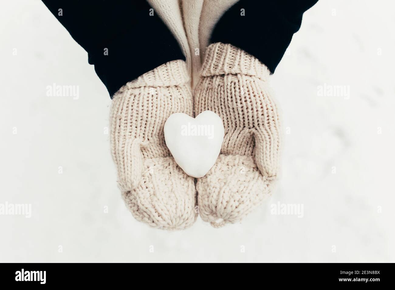 Snow heart snowball in girl gloved hands. Blurred background Stock ...