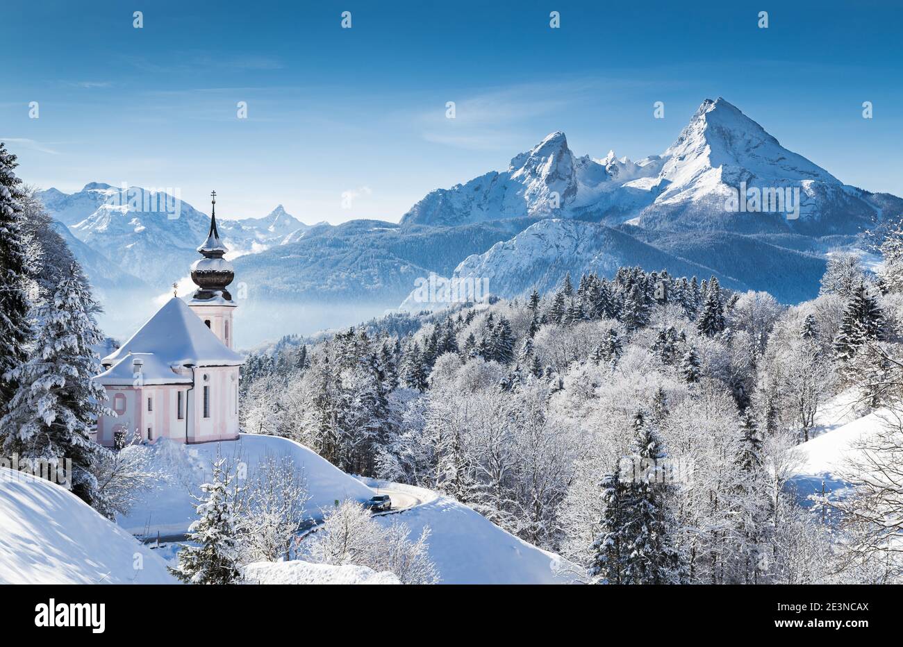 Alpine Church after morning snowfall in mountain. Church covered with ...