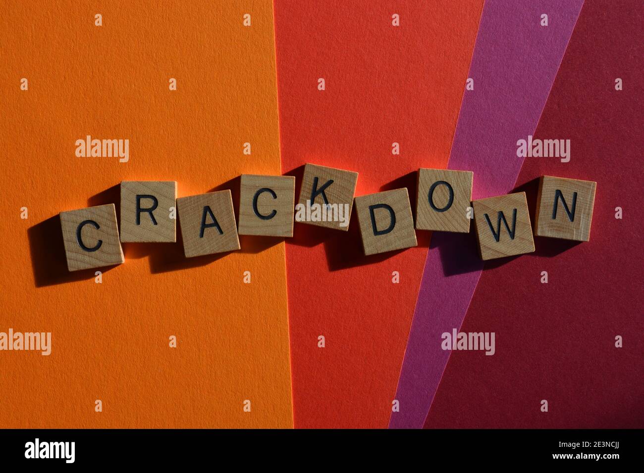 Crackdown, word in wooden alphabet letters isolated on colourful ...