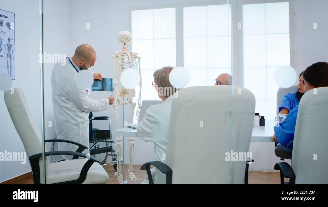 Professional physician learning colleagues body bone functionson using ...